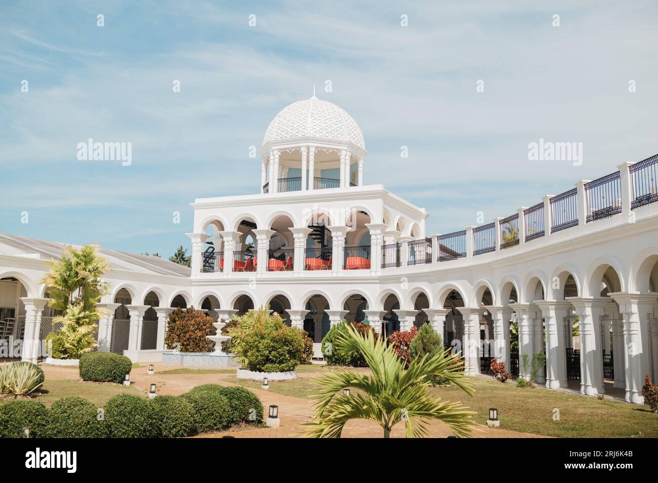 A modern building with two entrances and multiple columns illuminated ...