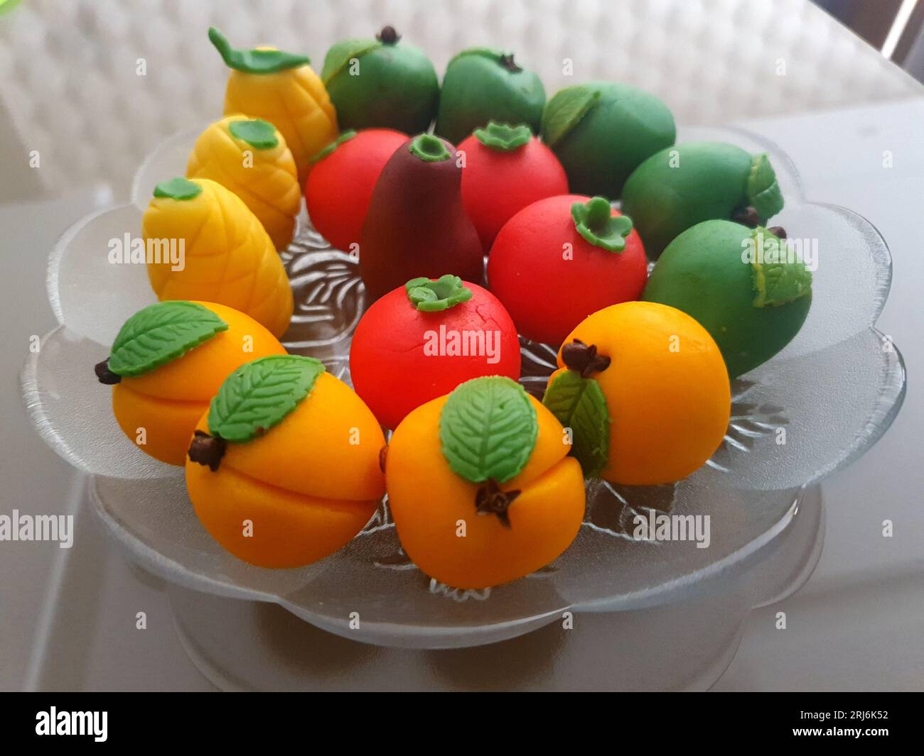 A vibrant and cheerful display of fake fruit on a circular plate Stock ...