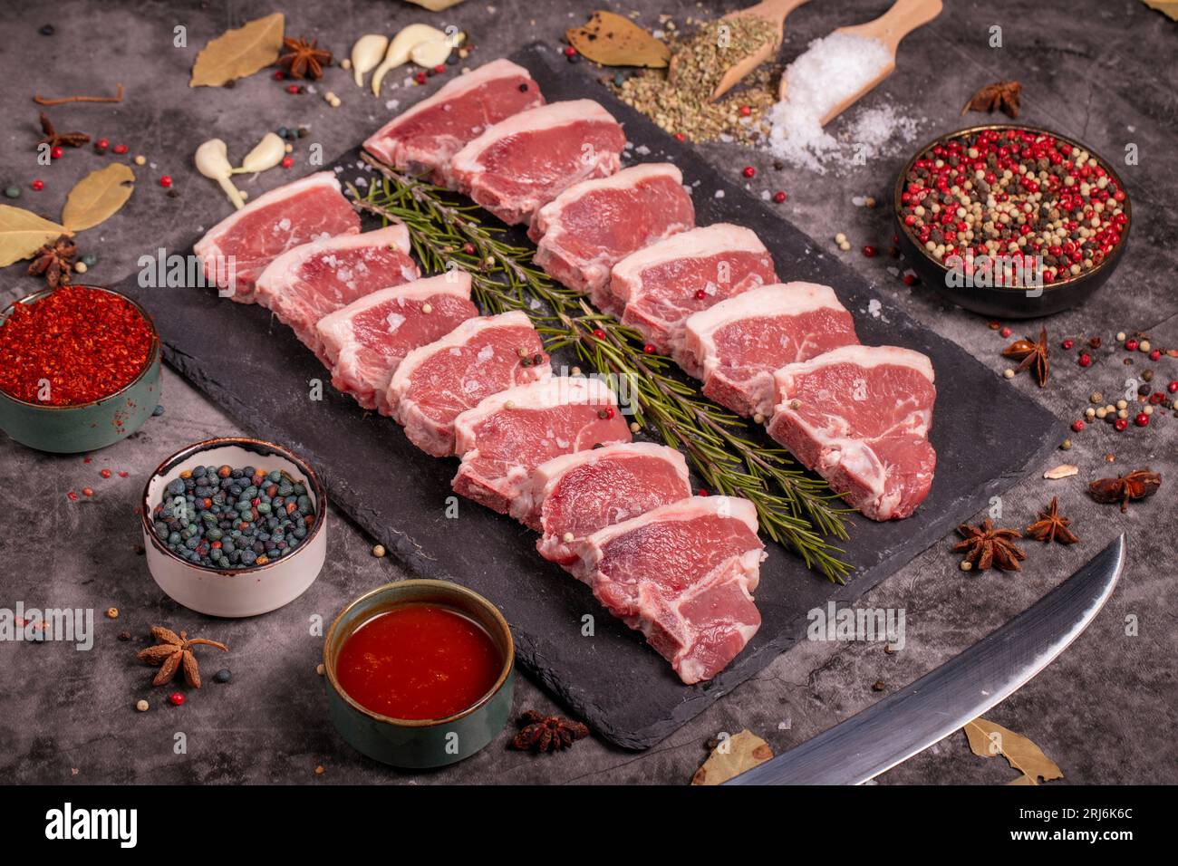 Fresh lamb back fillet. Raw lamb fillet on dark background. Butcher ...
