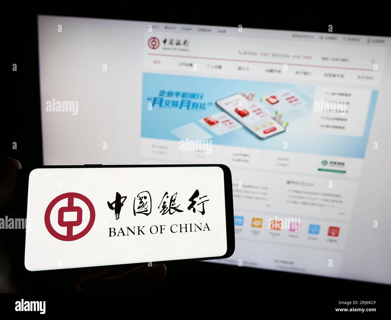 Person holding smartphone with logo of financial company Bank of China ...