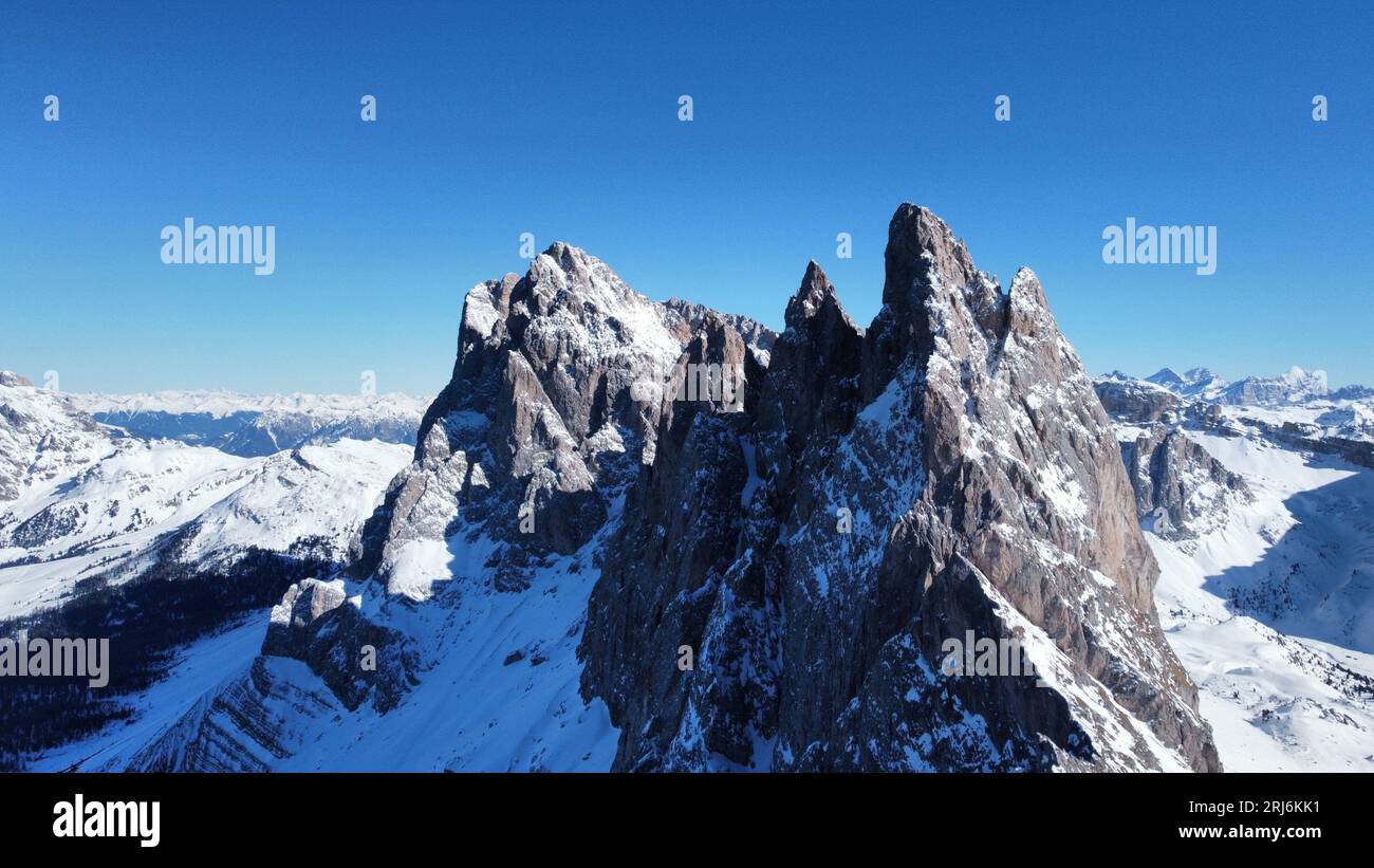 A stunning image of an alpine mountain range in the winter, blanketed ...