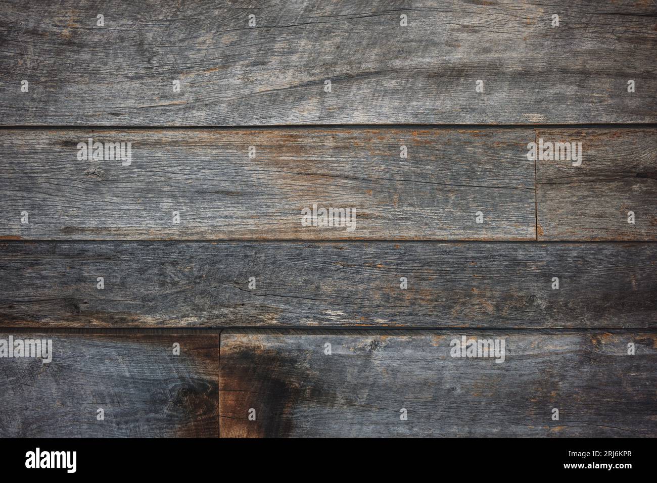 This stock photo features an aged, wooden floor with a rust-stained ...