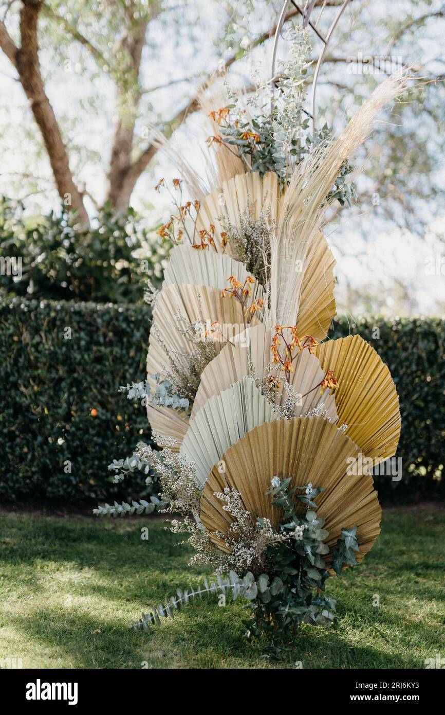 A beautiful boho-style wedding featuring a fan-shaped floral decoration ...
