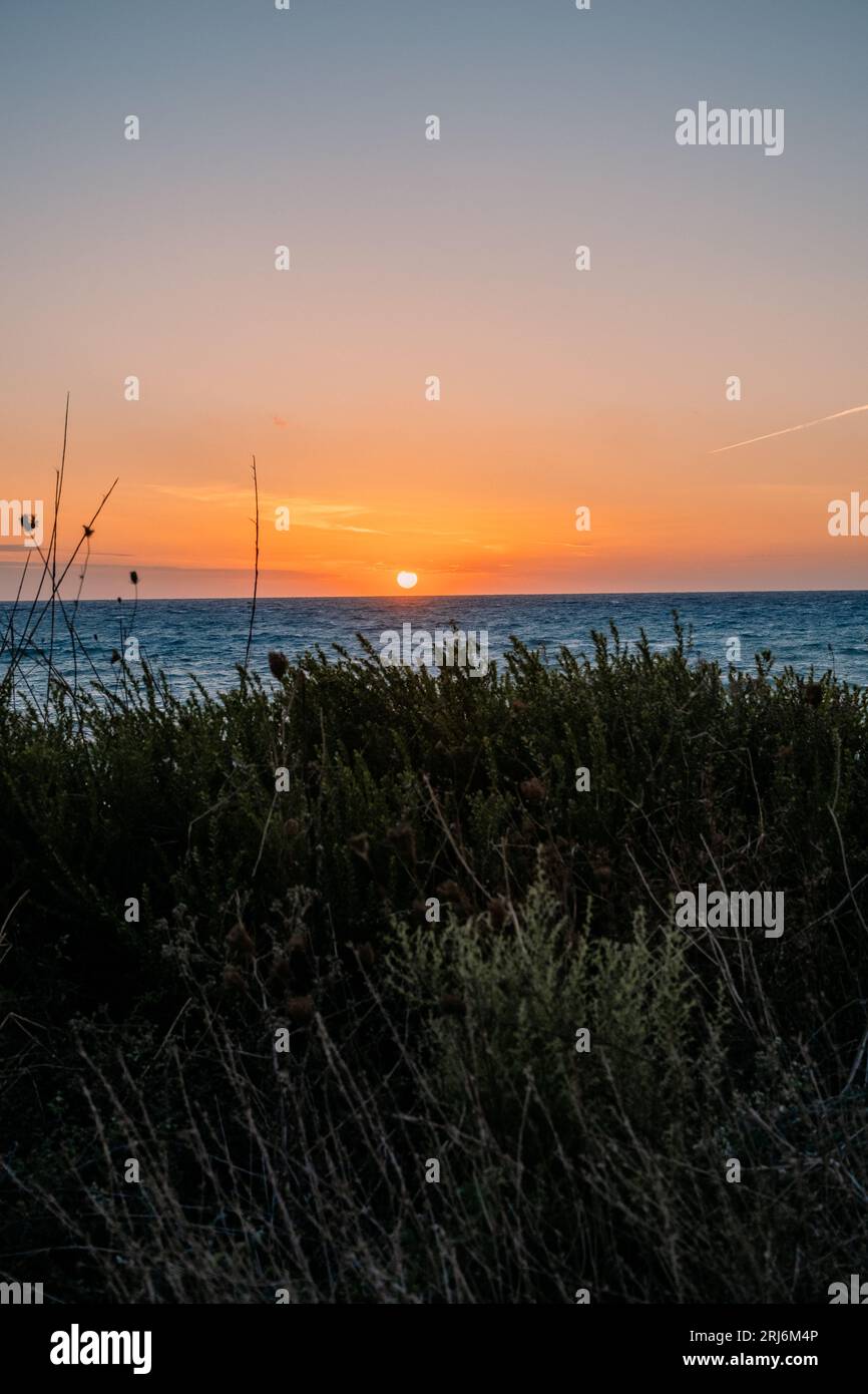 Beautiful sunset on the beach in Greece overlooking the endless ocean ...
