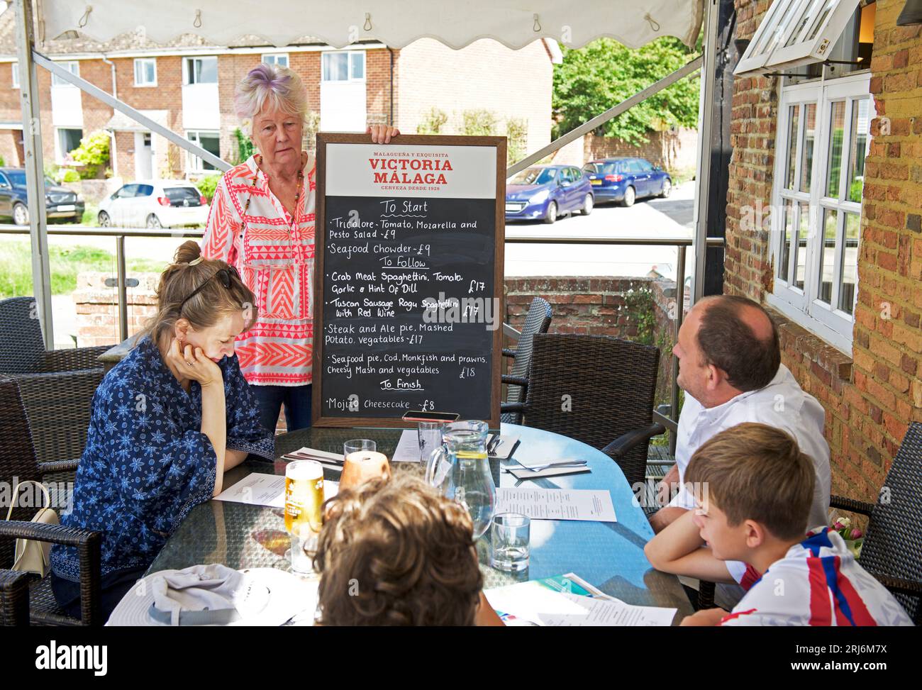 Family perusing the menu at the Pheasant pub, Brill, Buckinghamshire ...