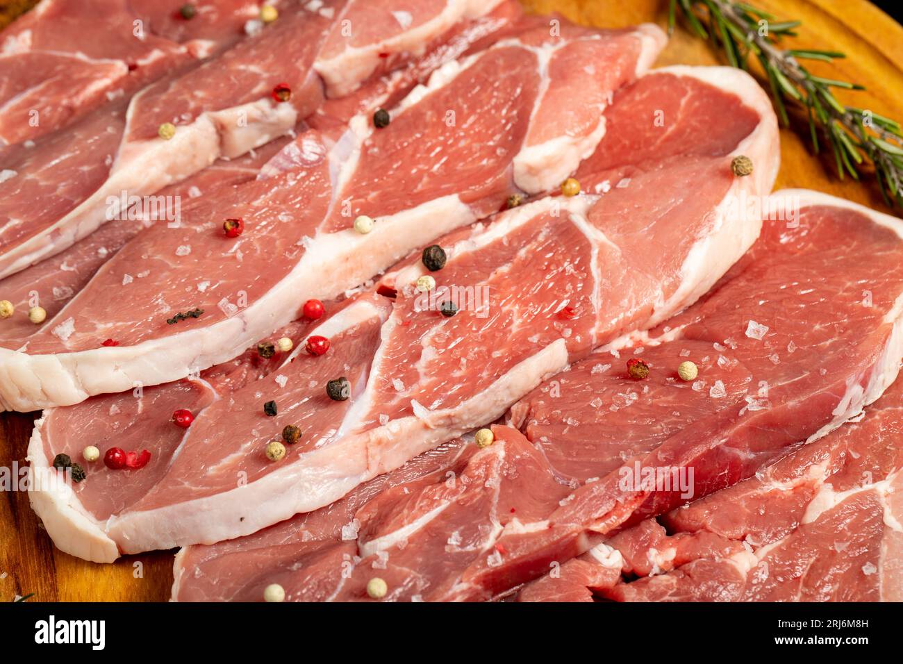 Boneless lamb thigh meat. Raw lamb leg meat on a dark background ...