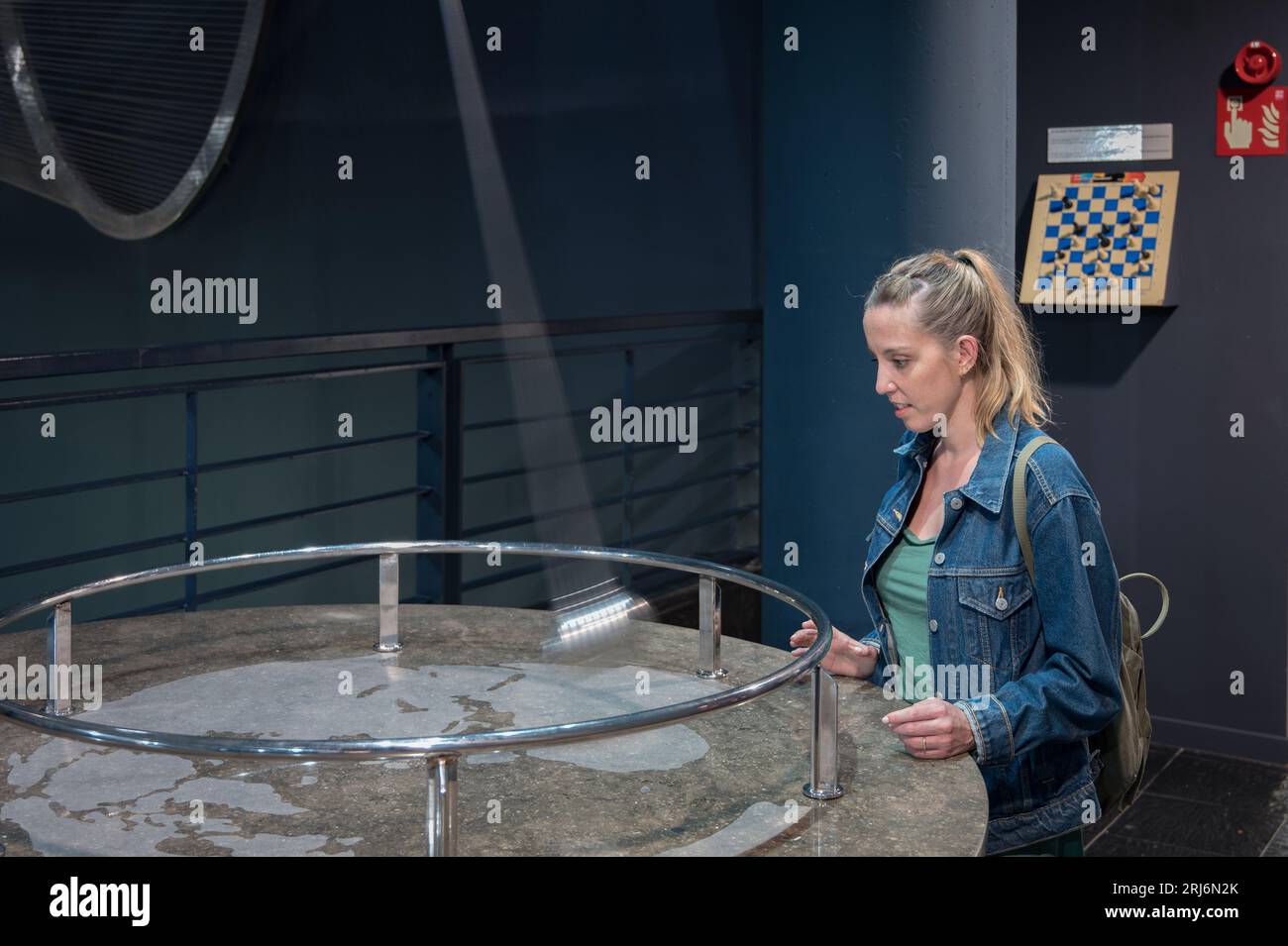 Young girl in museum science lab playing with pendulum Stock Photo - Alamy