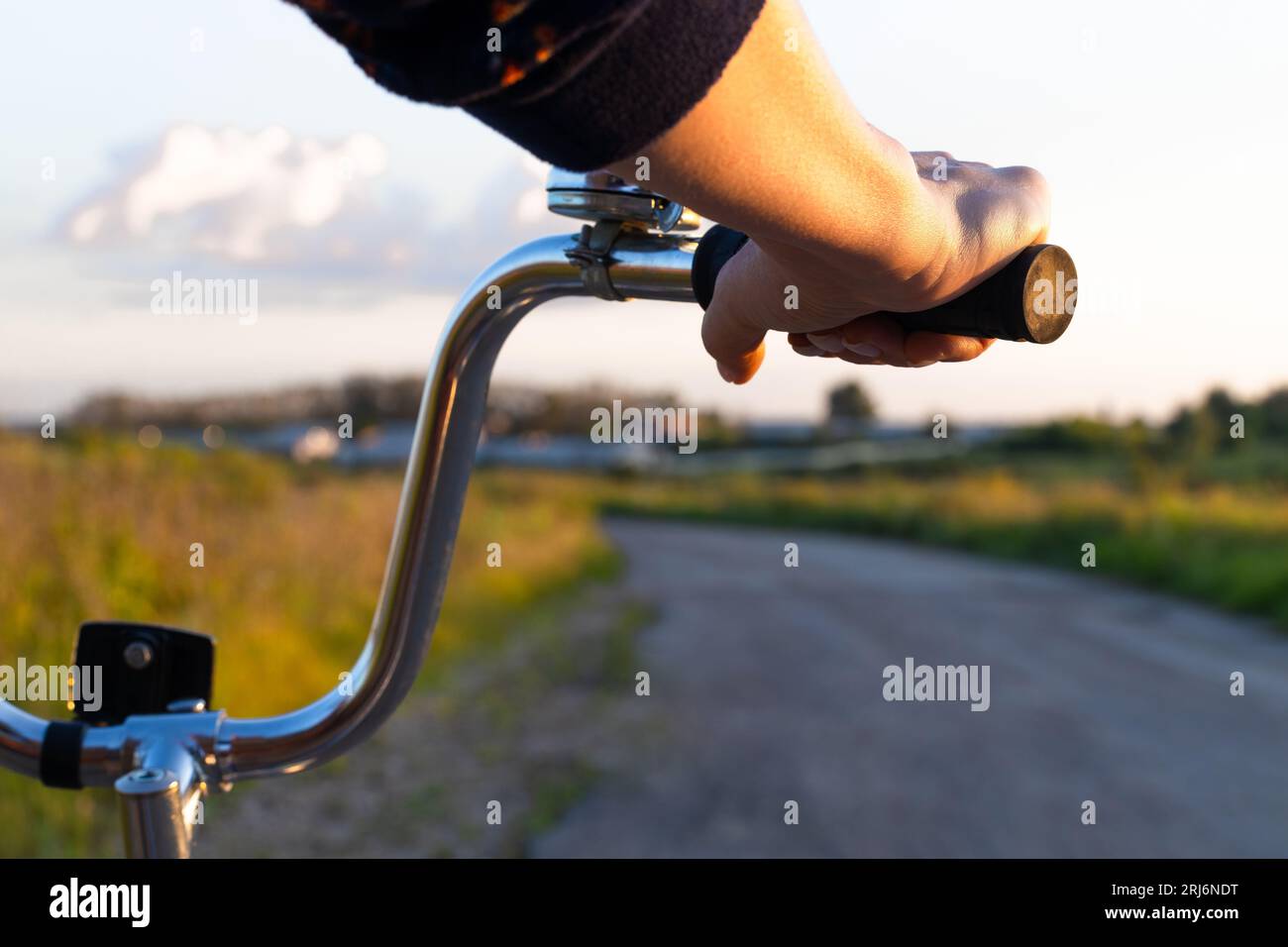 girl riding a bike on a country road. woman riding a bike on an empty ...