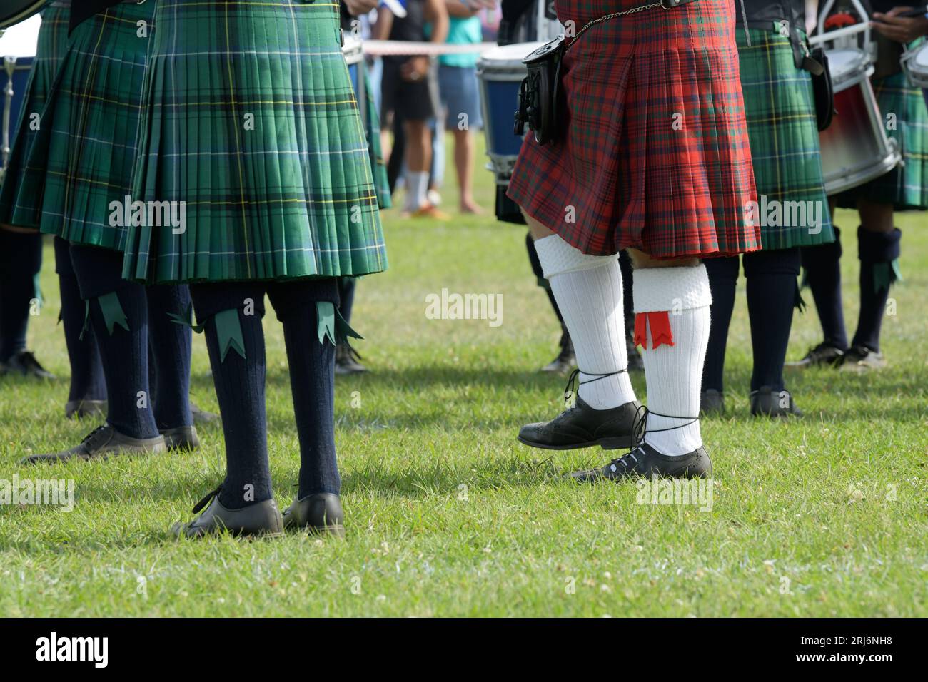 Legs of people, tartan kilt dress, traditional Scottish culture, pipes ...