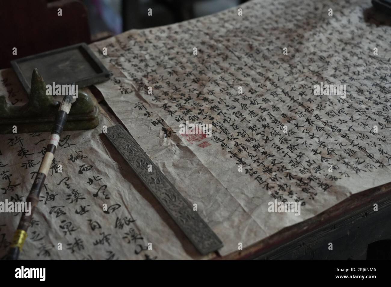 A traditional calligraphy brush on paper with Chinese lettering Stock ...