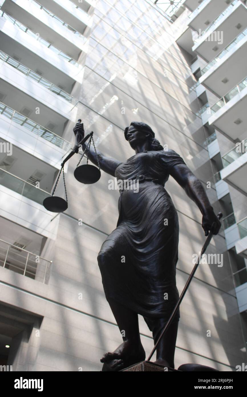 Statue of a female judge representing justice and law inside the ...