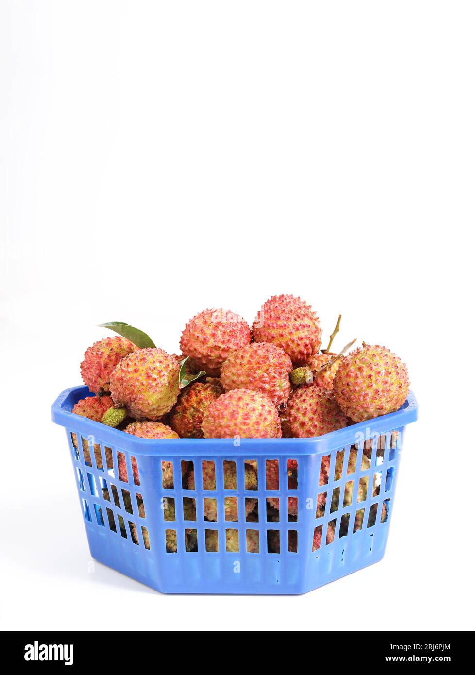 A basket overflowing with lusciously ripe lychee fruits, all nestled ...