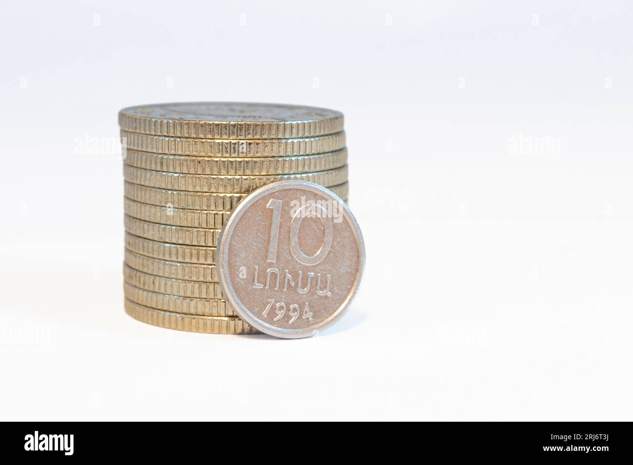 A stack of Armenian dram coins, luma denomination on the white ...