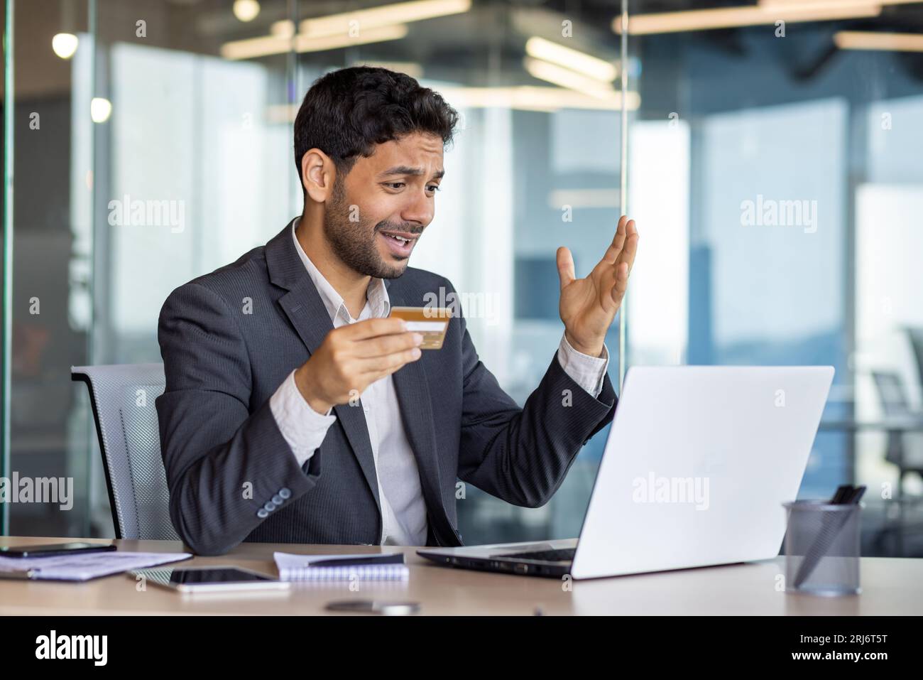Cheated and unsatisfied disappointed businessman with bank credit card ...
