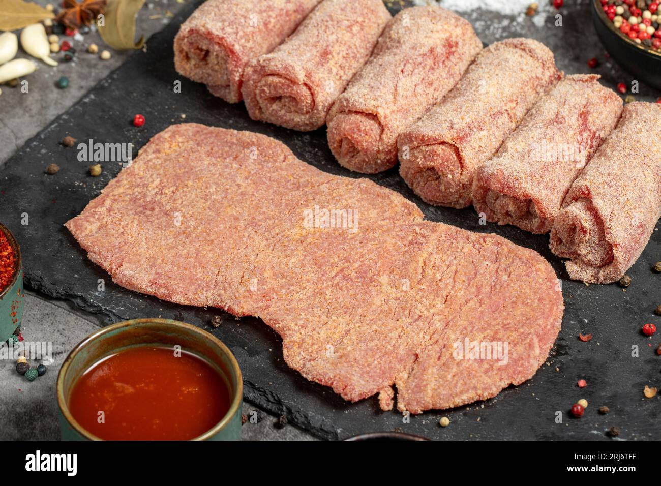Meat schnitzel. Raw beef schnitzel on dark background. Butcher products ...