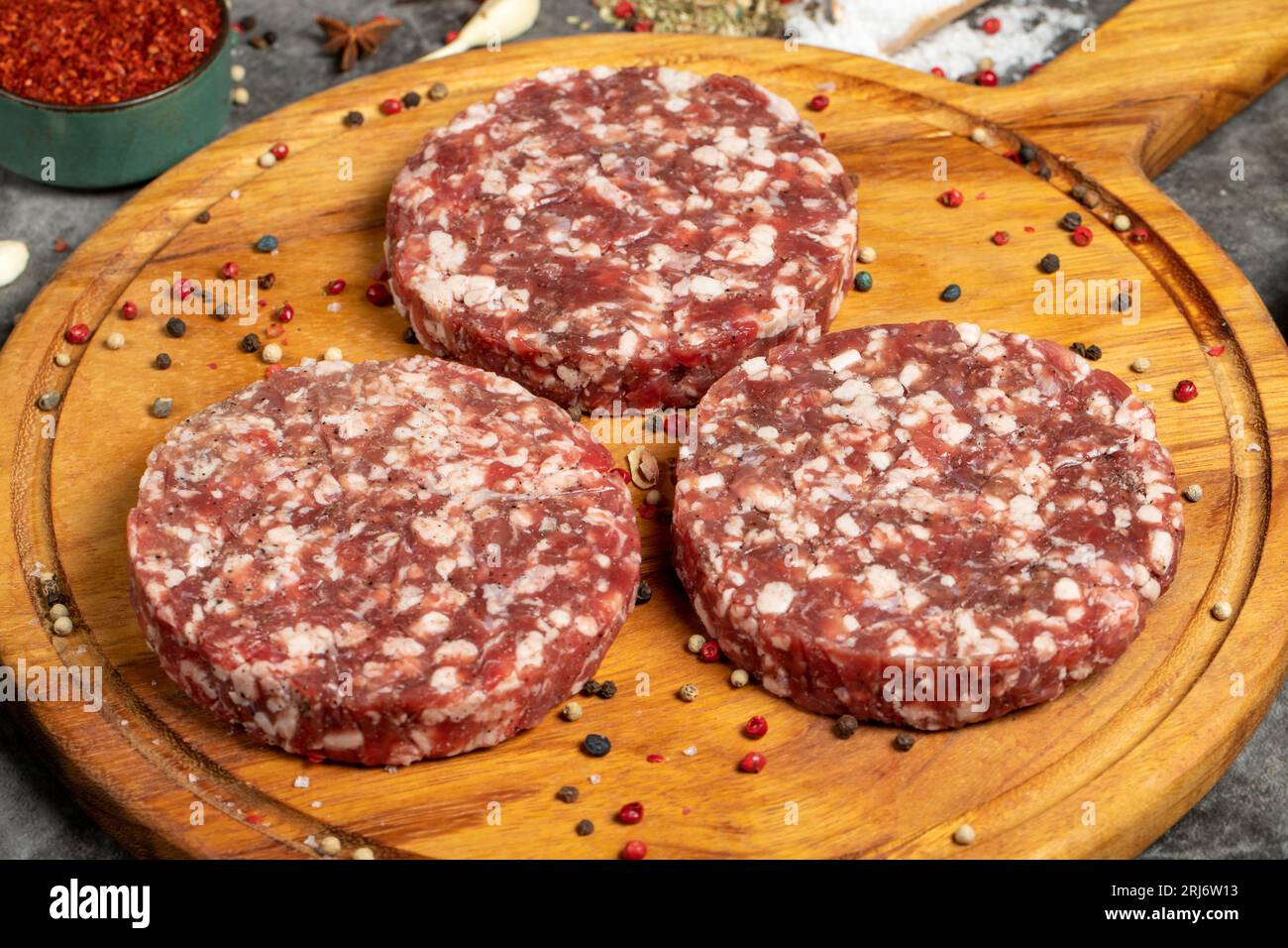 Beef hamburger patty. Fresh raw beef burger patties on dark background ...