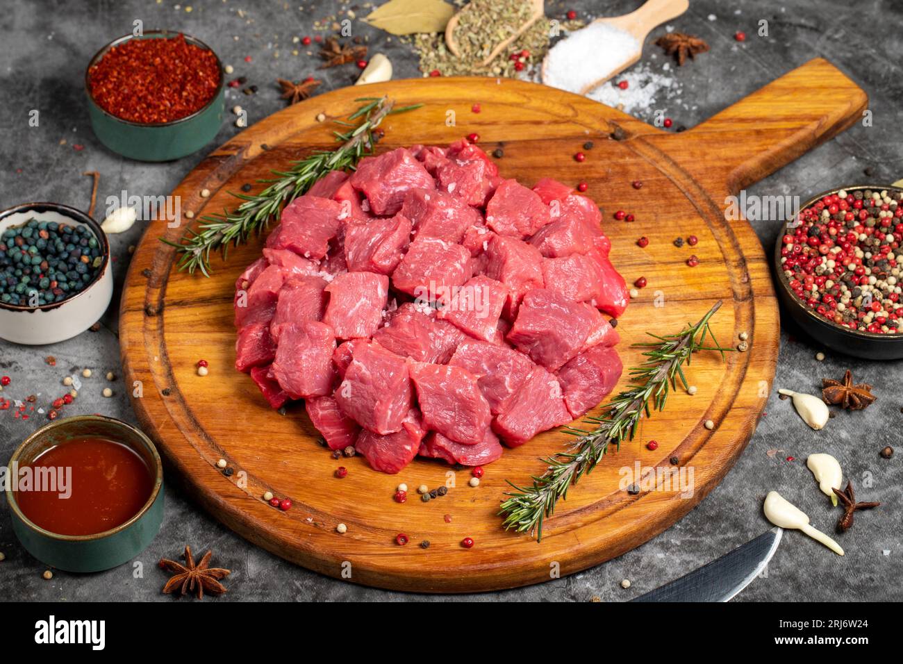 Beef cubed. Fresh raw beef diced meat on dark background. Butcher ...
