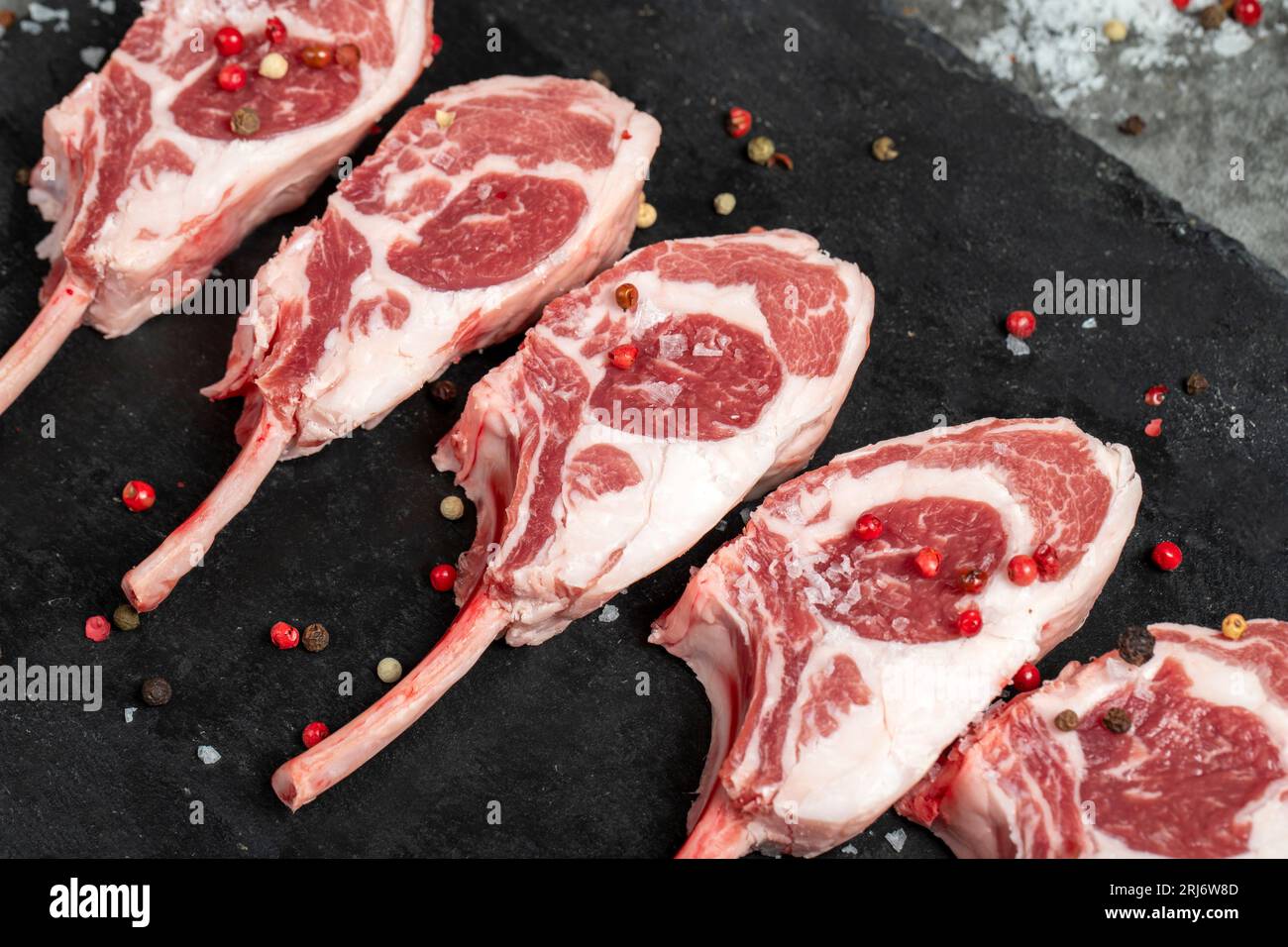 Lamb chops. Fresh raw lamb chops on dark background. Butcher products ...