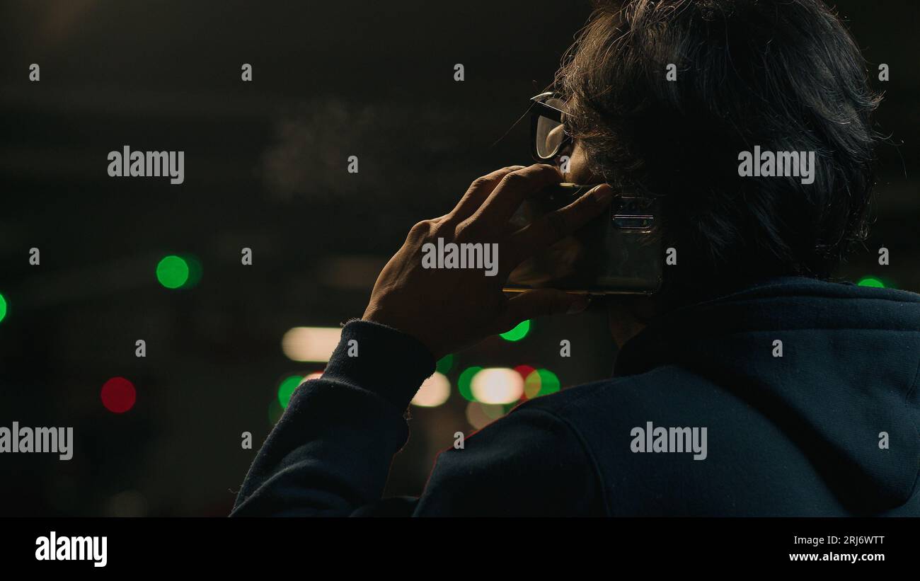 Back view from behind male in glasses at parking lot dark underground ...