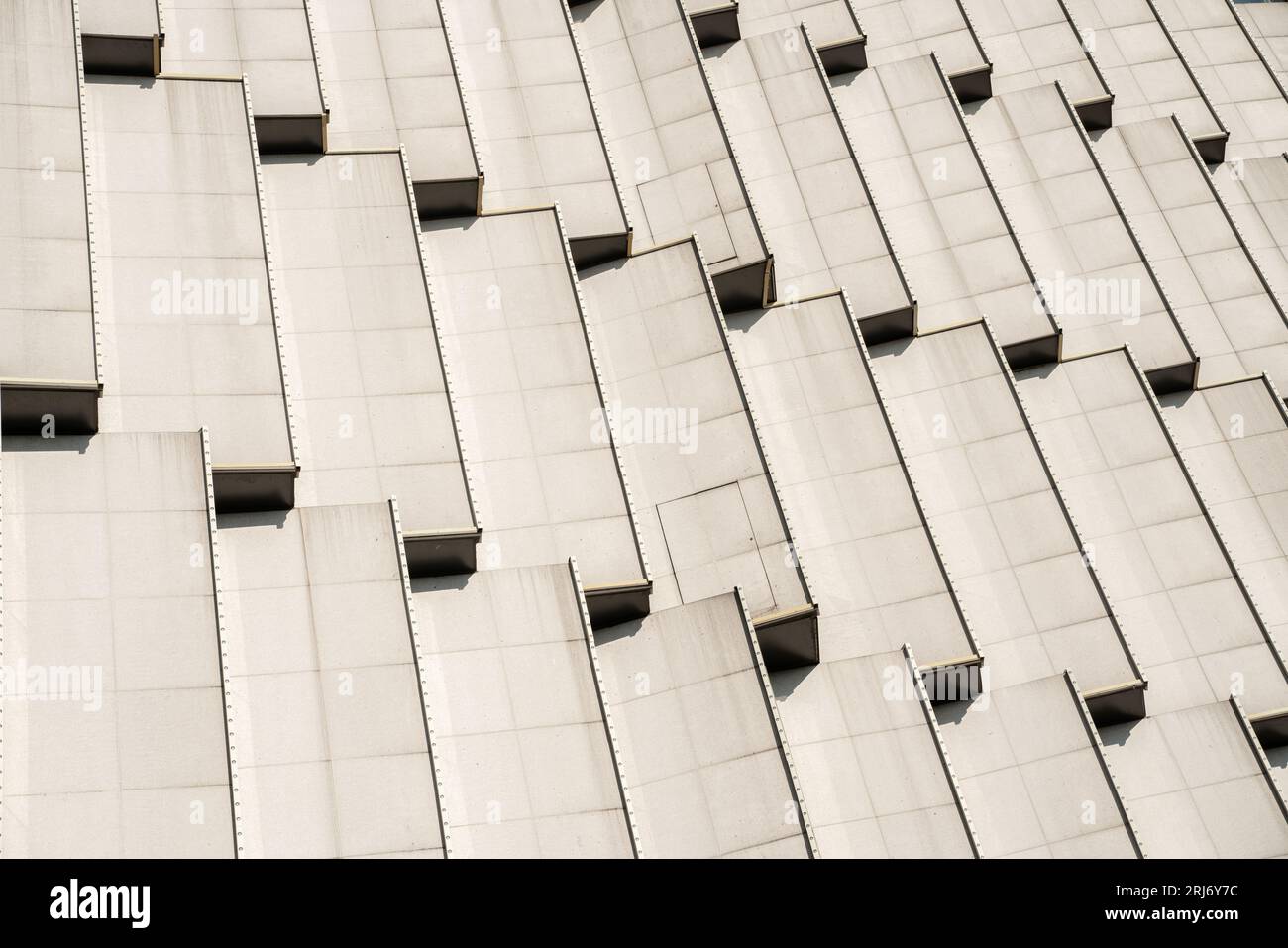 a modern high-rise building with an array of symmetrical square windows ...