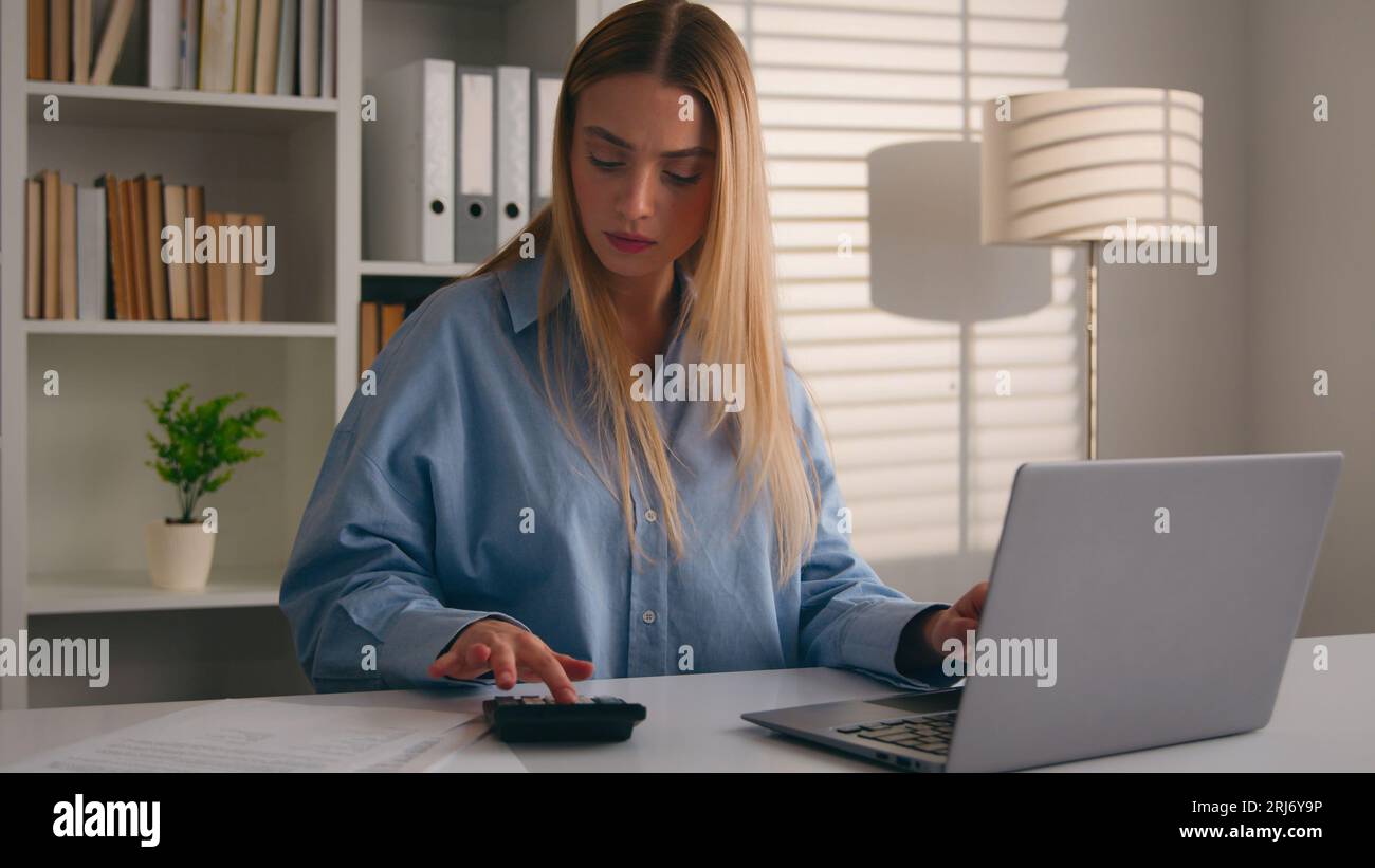 Confused puzzled Caucasian girl woman at office counting money business ...