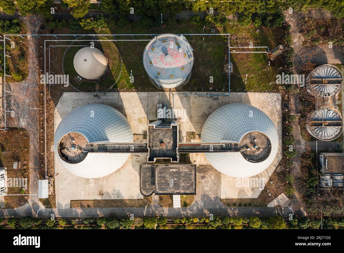 An aerial view of a tank manufacturing facility situated beside a lush ...