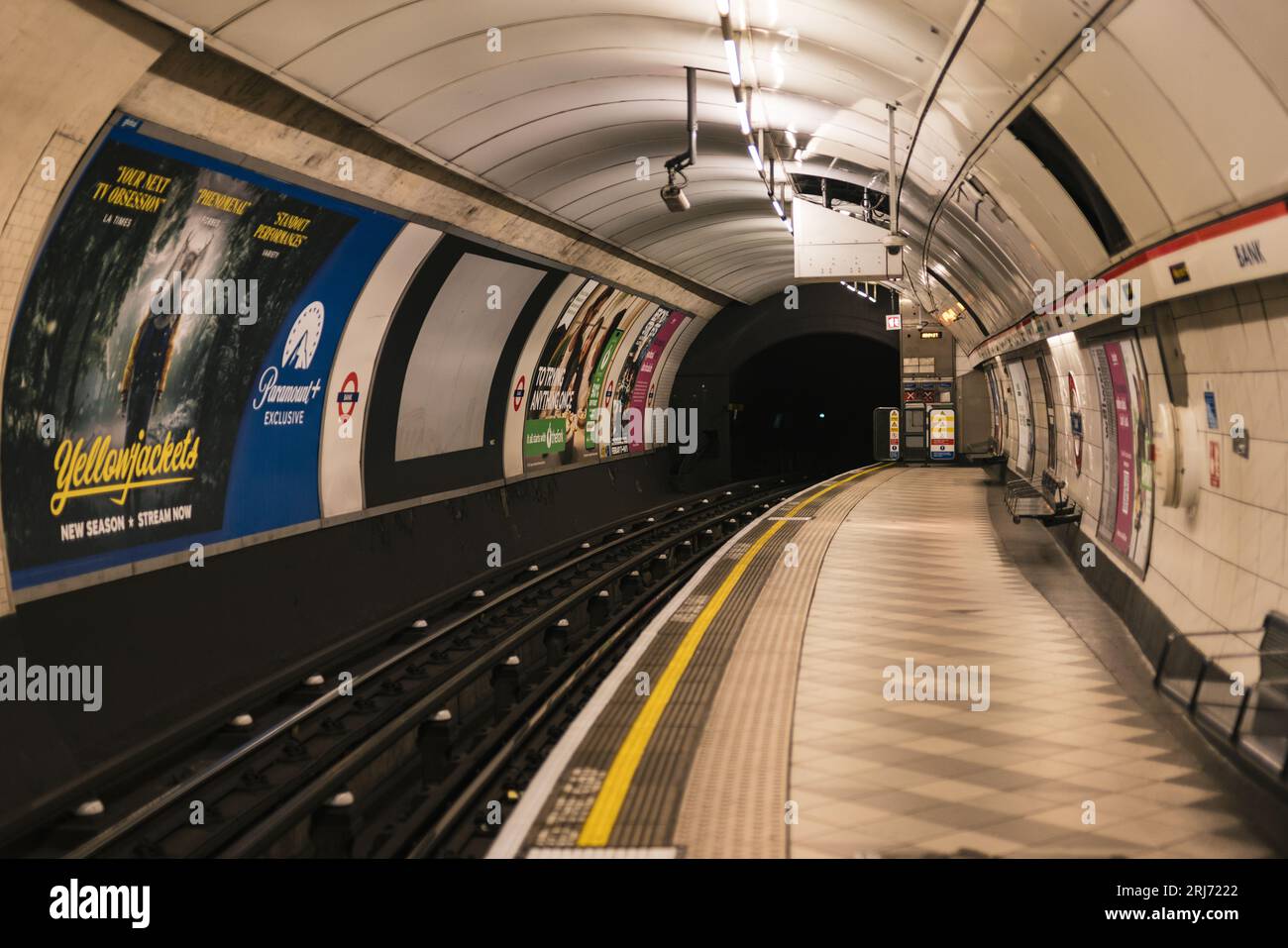 A bustling subway station featuring a long platform with large-scale ...