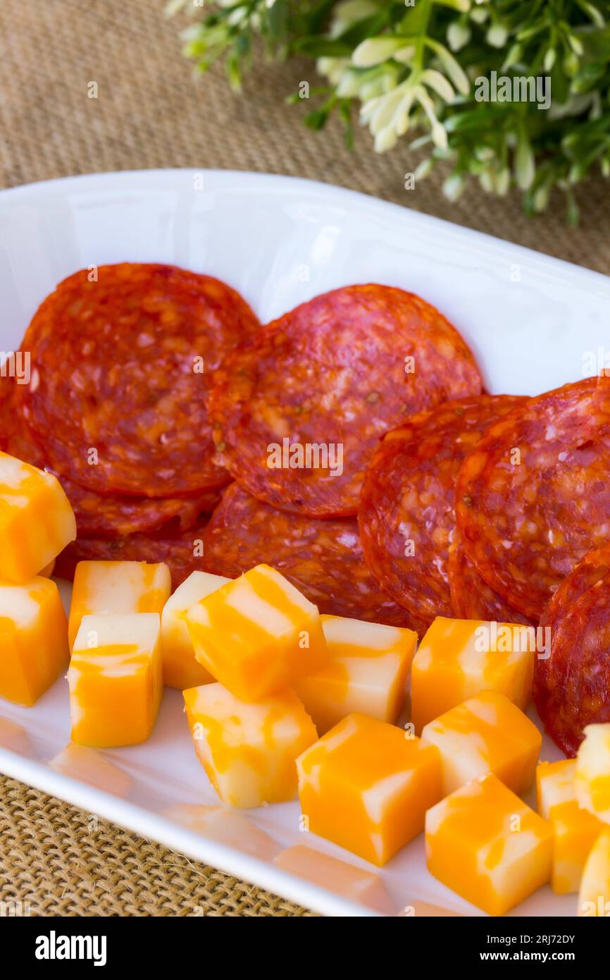 A long white platter with sliced cheese and pepperoni Stock Photo - Alamy