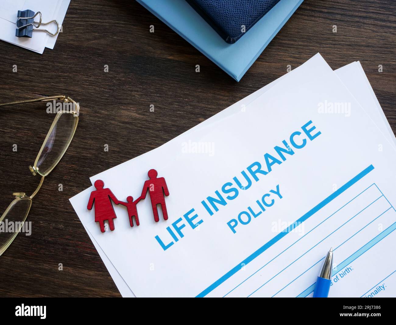 Life insurance policy and figurines of family Stock Photo - Alamy