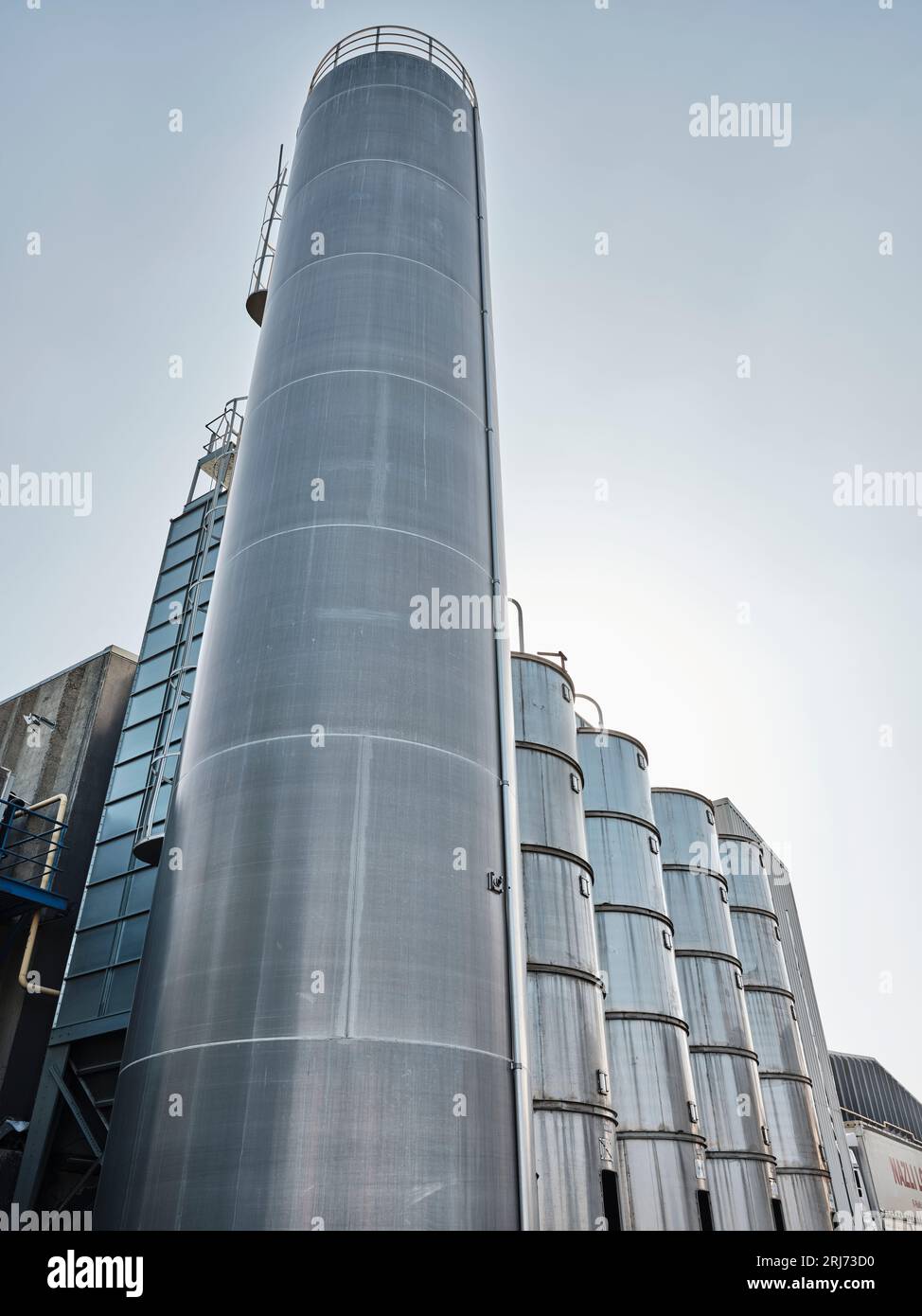 five silver/metallic silos beside each other. silo. tall silo Stock ...