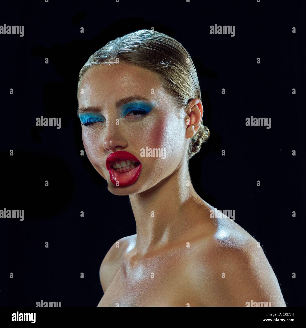 Strong wind blowing on woman's face with bright colorful make-up ...