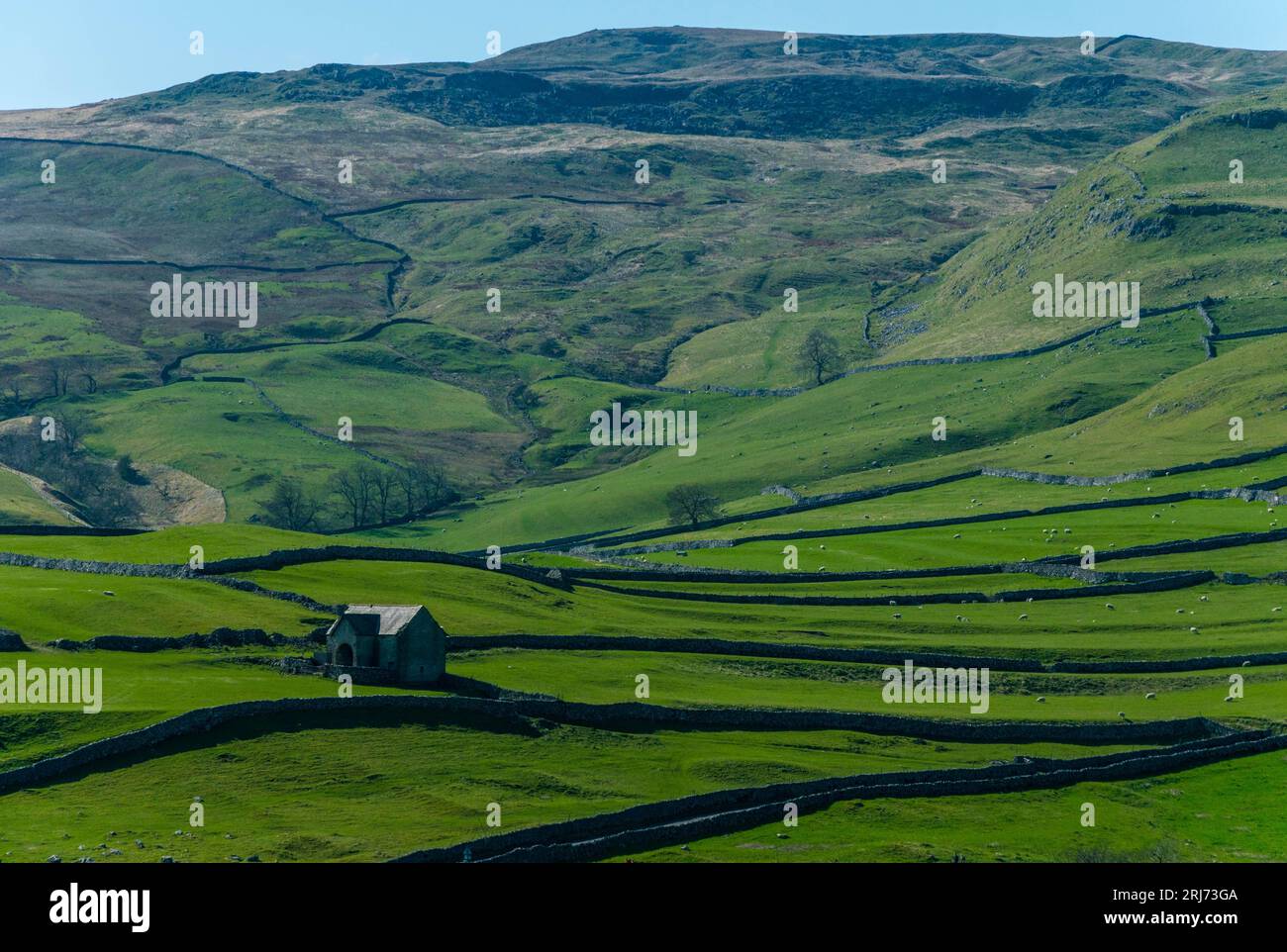 An aerial view of a stone building in a vast rural landscape of the UK ...