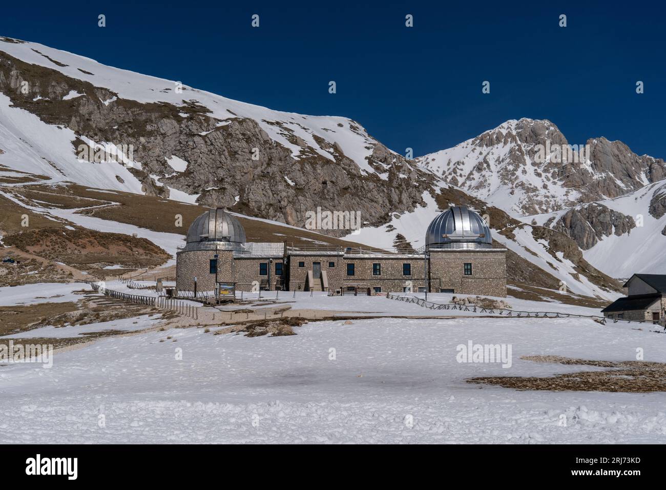 An aerial view of a snow-capped mountain with the Observatory of ...