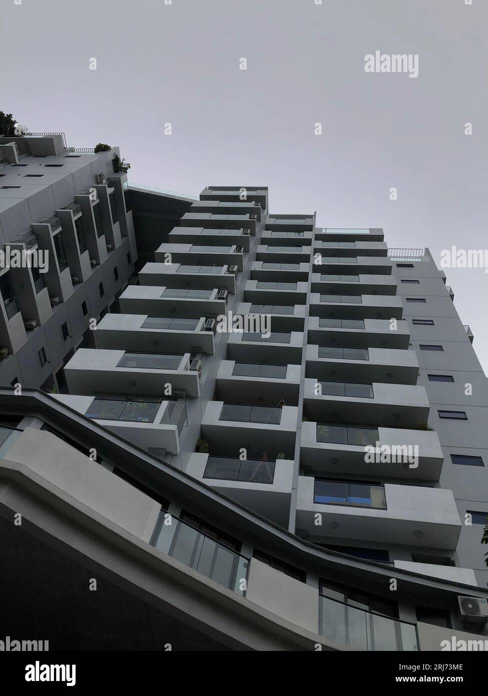 A modern residential high-rise building with balconies Stock Photo - Alamy