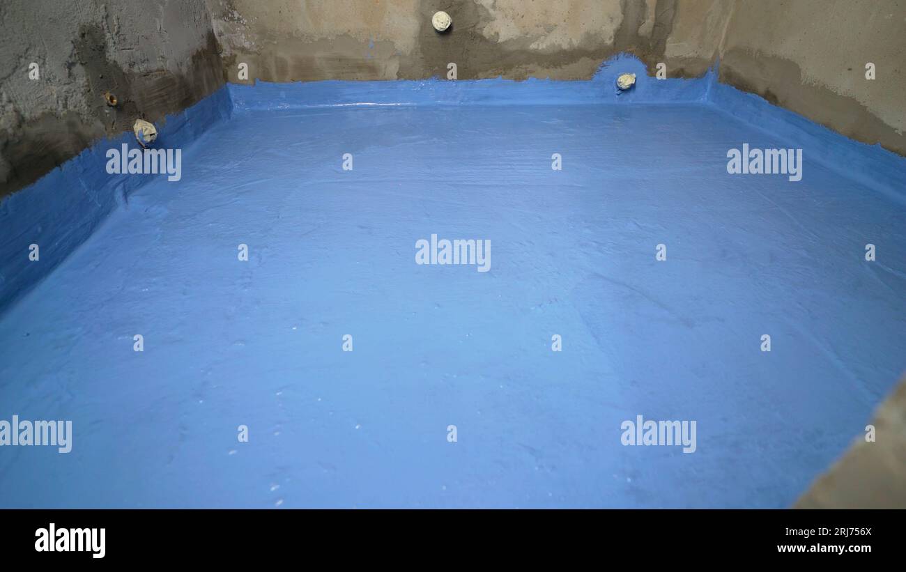 Applying waterproof paint to the floor. Waterproofing the floor in a ...