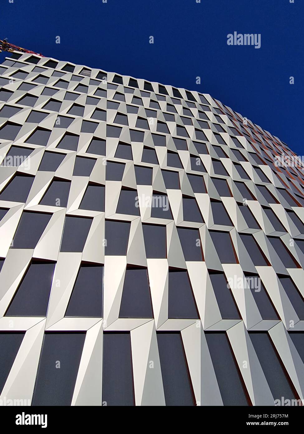 A high-rise office building with a bold, geometric design on its facade ...