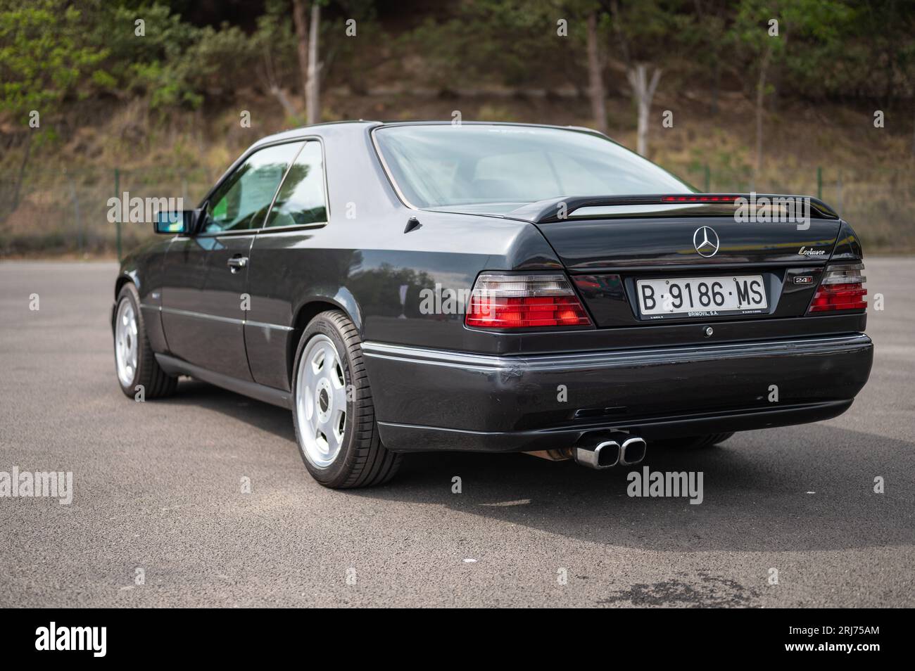 Rear view of a luxurious black colored Mercedes Benz C124 Lorinser ...