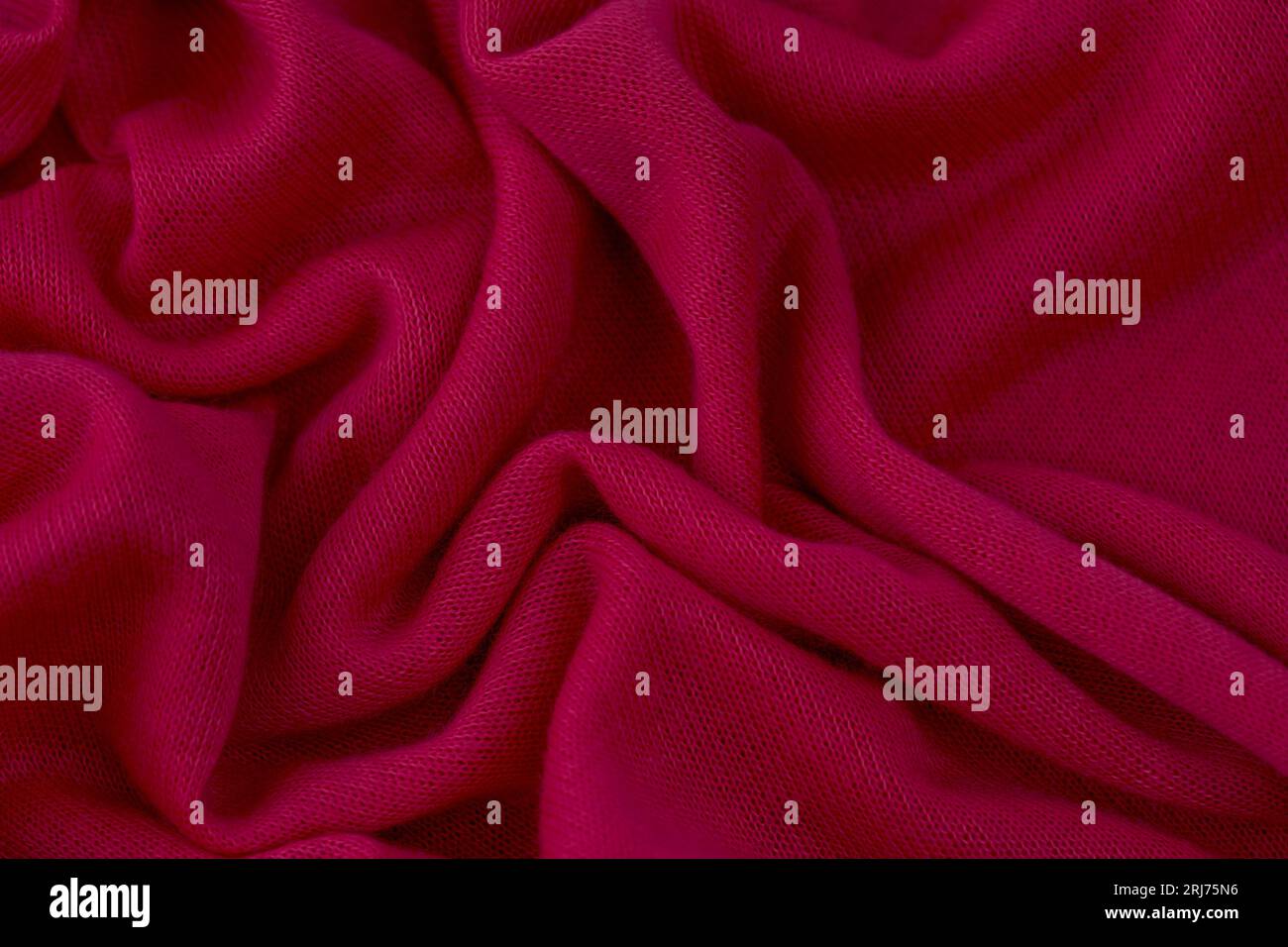 A pink toned blanket with large and deep pleats and a textured fabric ...