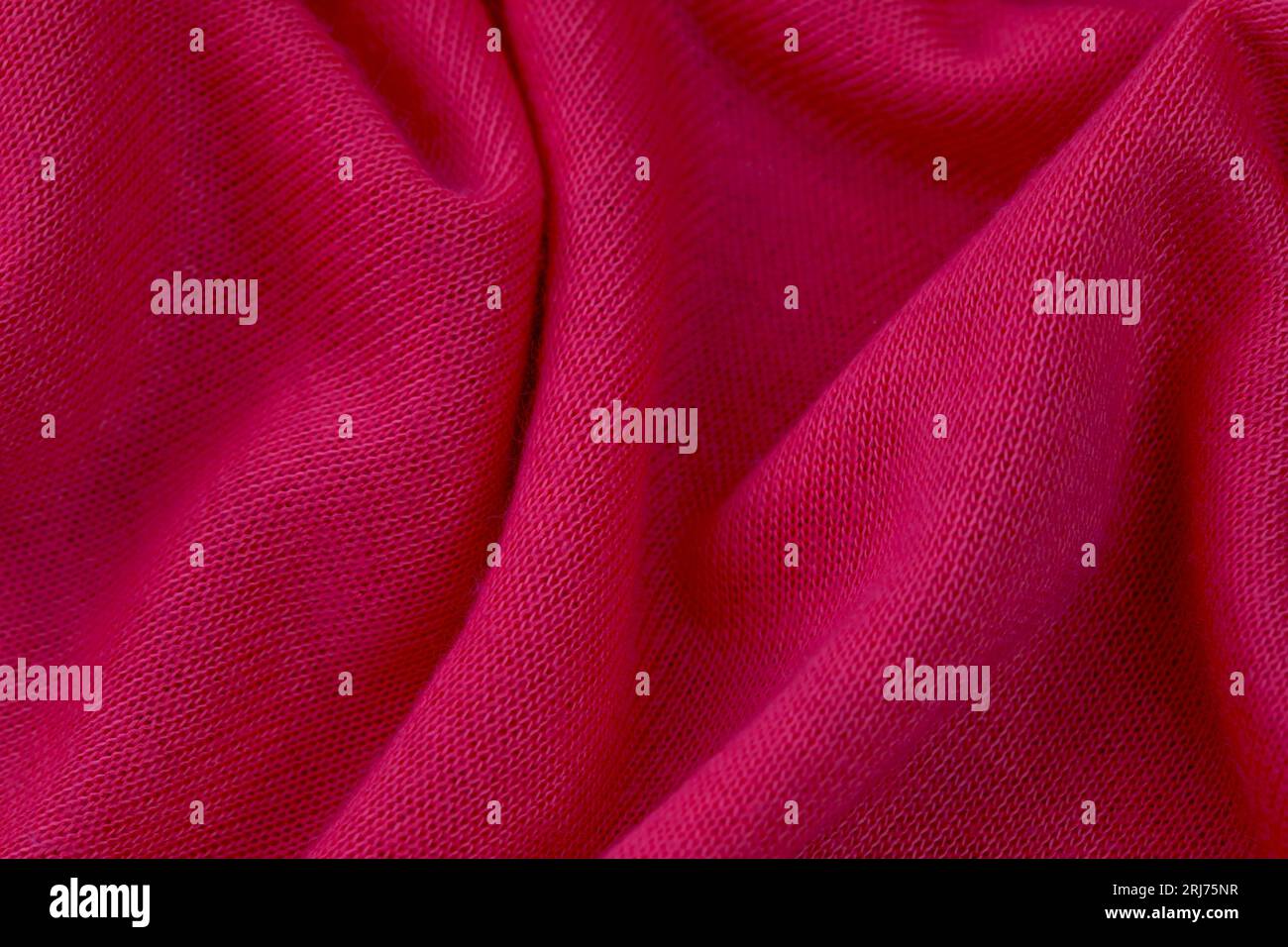 A closeup image of a soft, pink fabric texture with subtle details of ...
