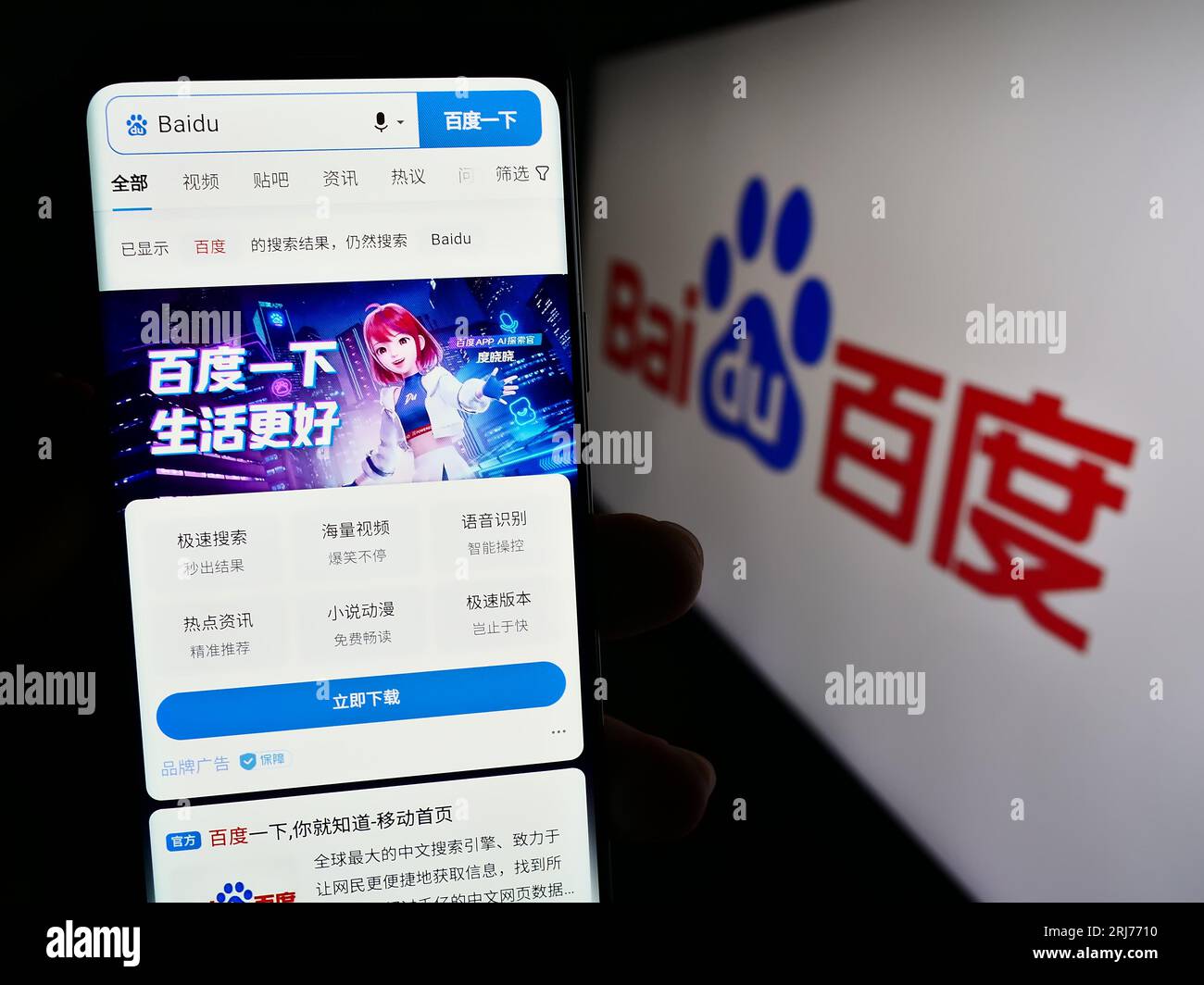 Person holding mobile phone with web page of Chinese technology company Baidu Inc. on screen in ...