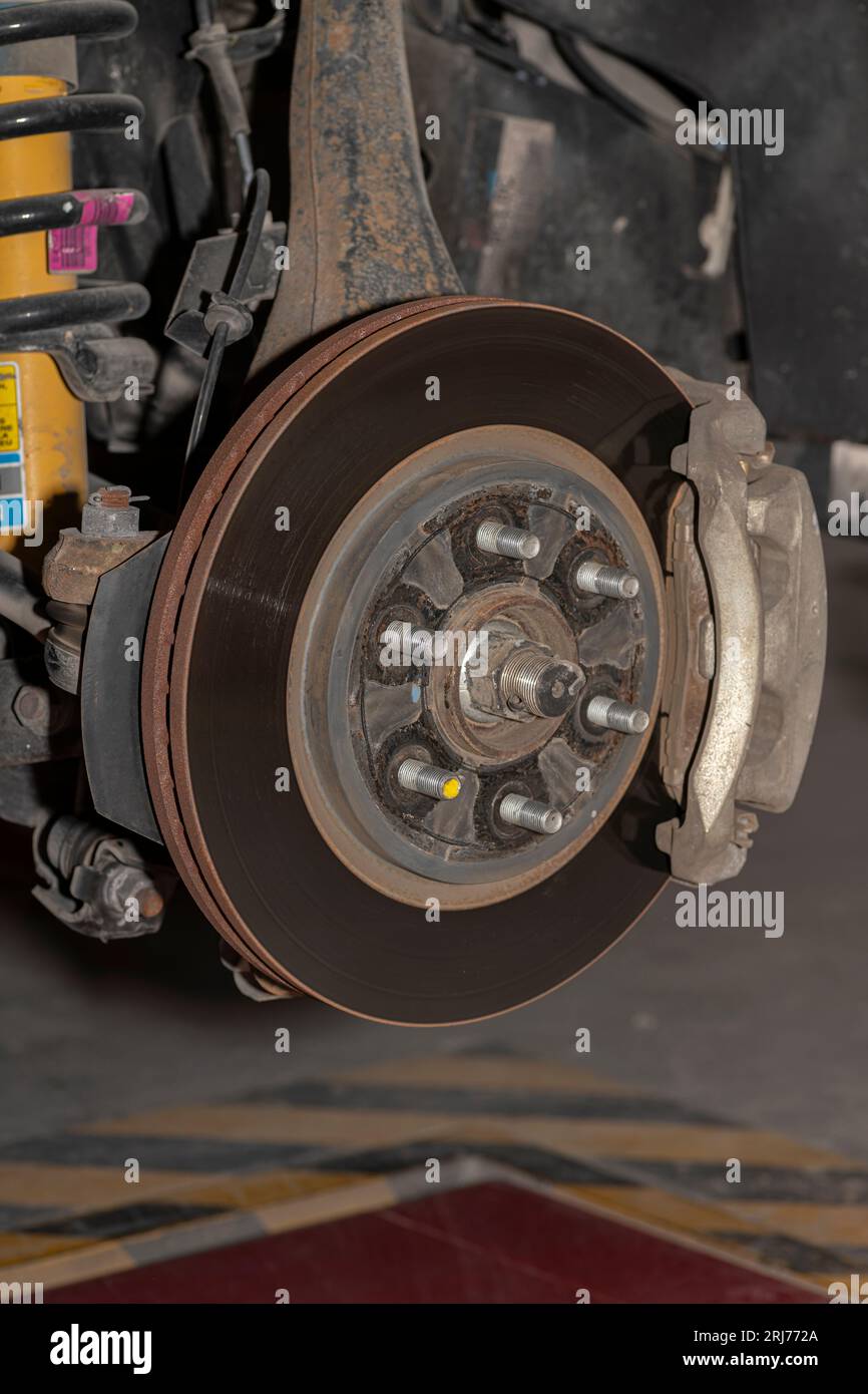 Front Used brake disc of an all-terrain vehicle in a garage for repair ...