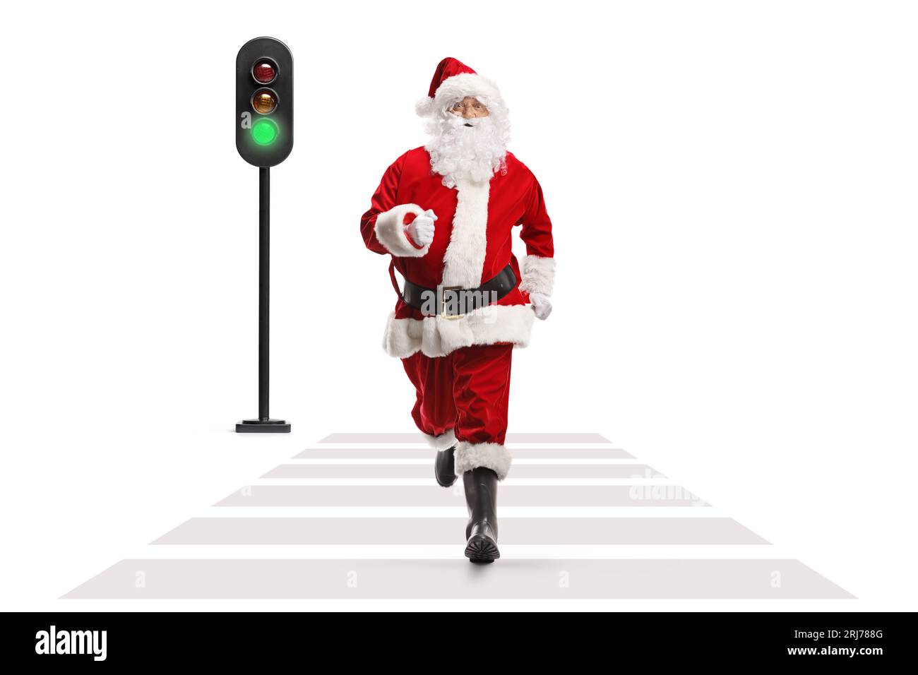 Full length shot of santa claus running at a pedestrian crosswalk ...