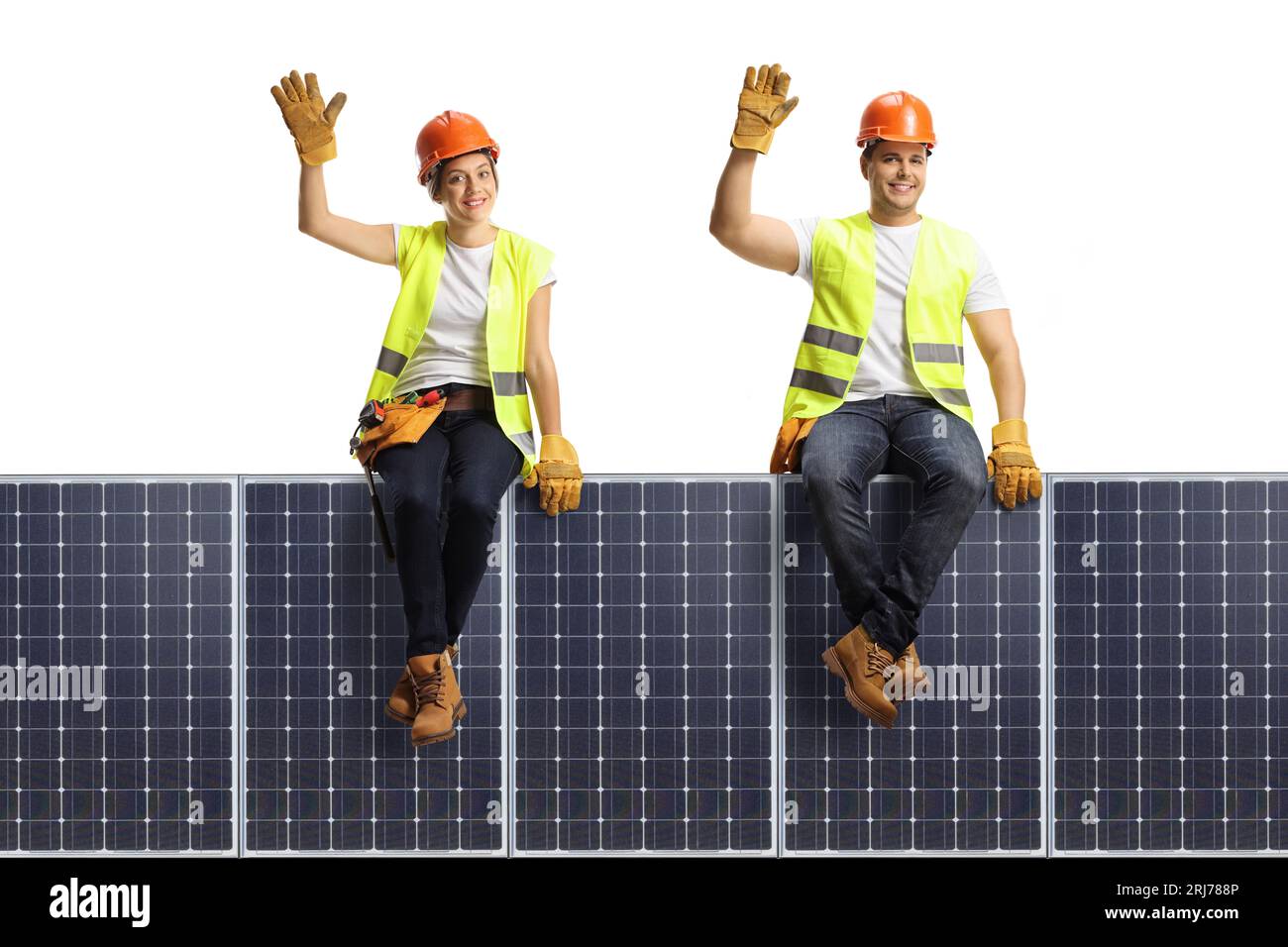 Male and female construction workers sitting on a solar panel and ...