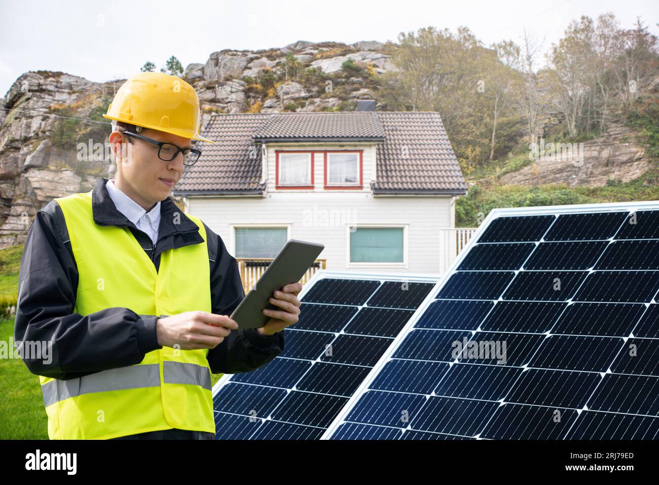 Engineer with tablet computer on a background of mobile solar energy ...