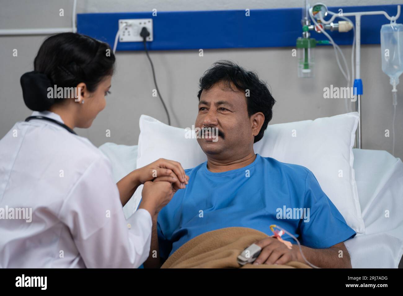 Shoulder shot of indian doctor consoling sick admitted recovered ...