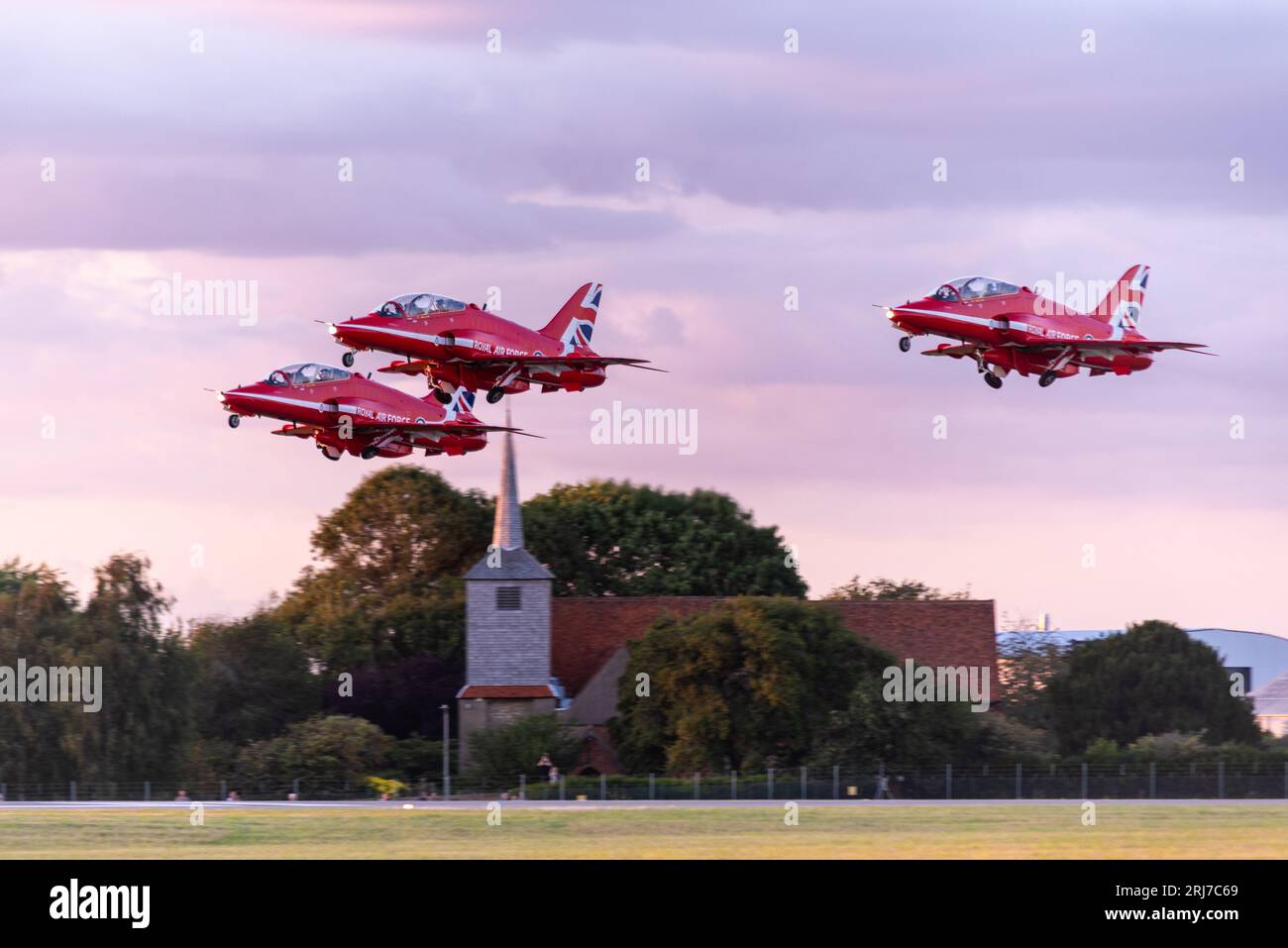 RAF Red Arrows taking off at dusk from London Southend Airport, Essex ...