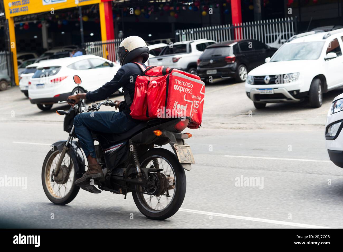 Salvador, Bahia, Brazil - August 11, 2023: A food delivery person using ...