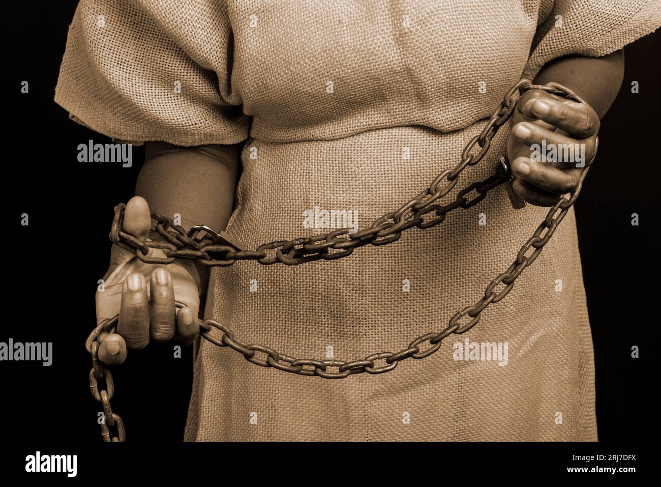 Portrait of a black woman in chains with an iron mask on her face representing the slave ...