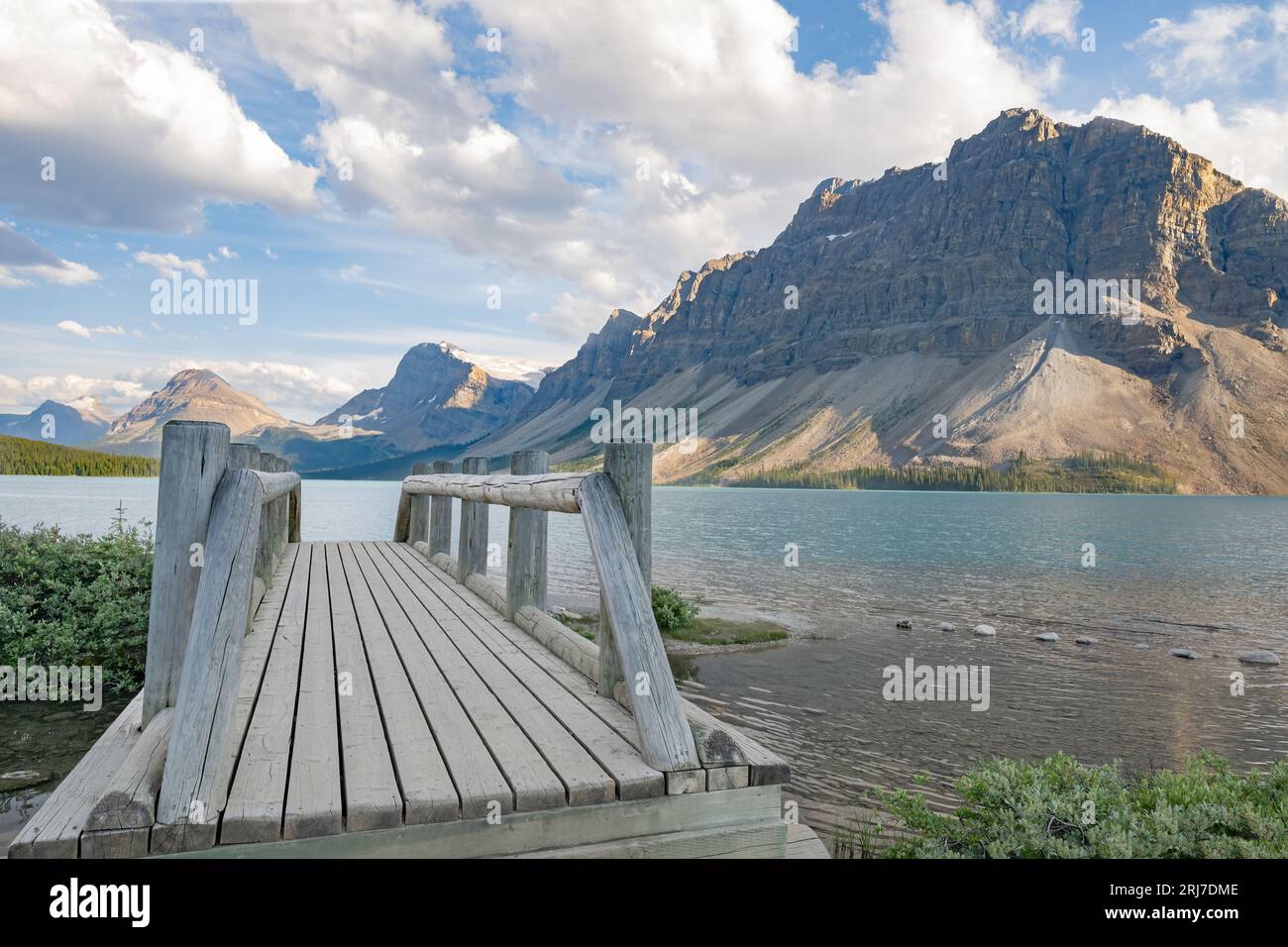 Wooden bridge across river looking onto Bow Lake, Icefields Parkway ...