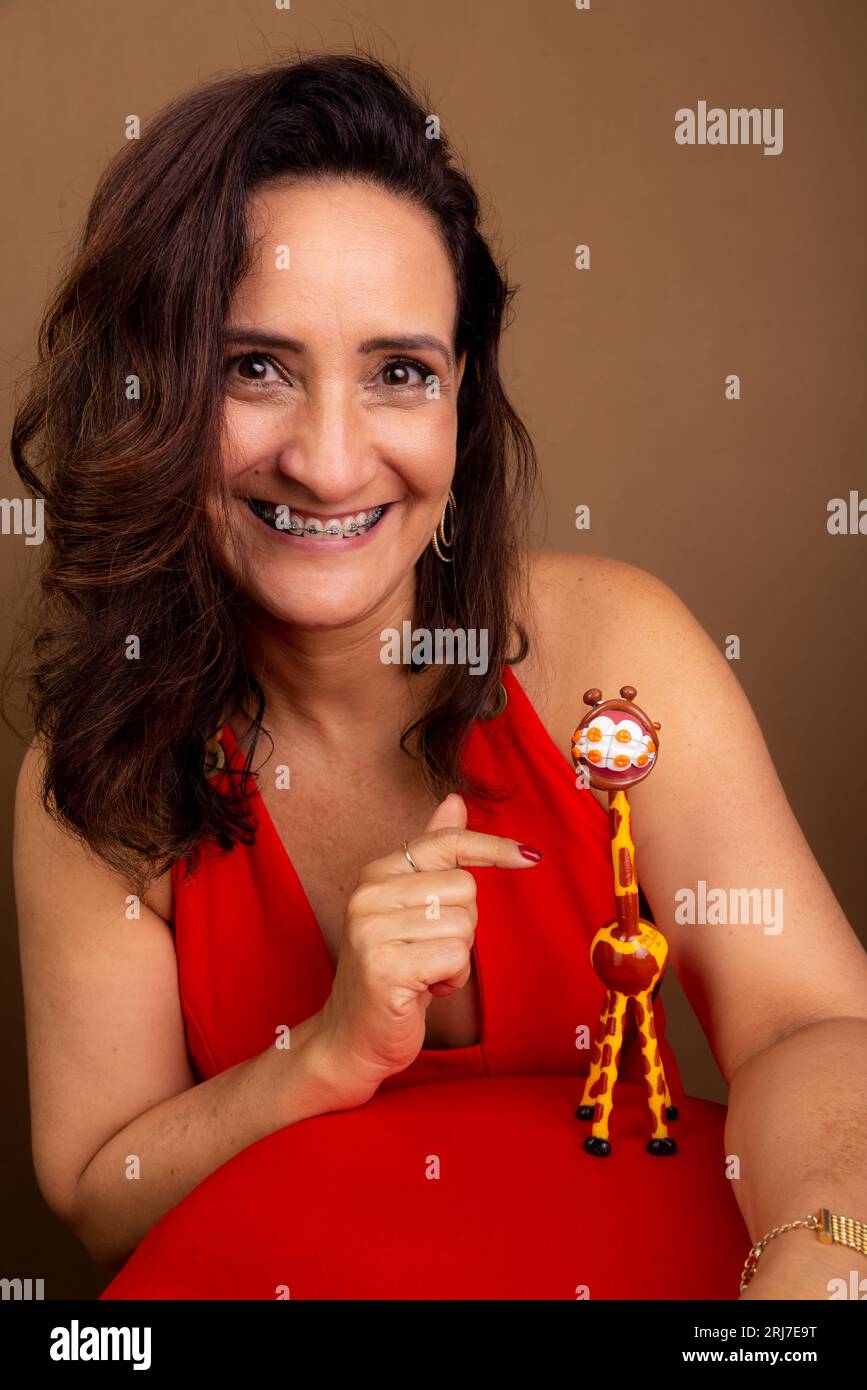 Cheerful coaching woman with a giraffe puppet. Symbol of non-violent ...